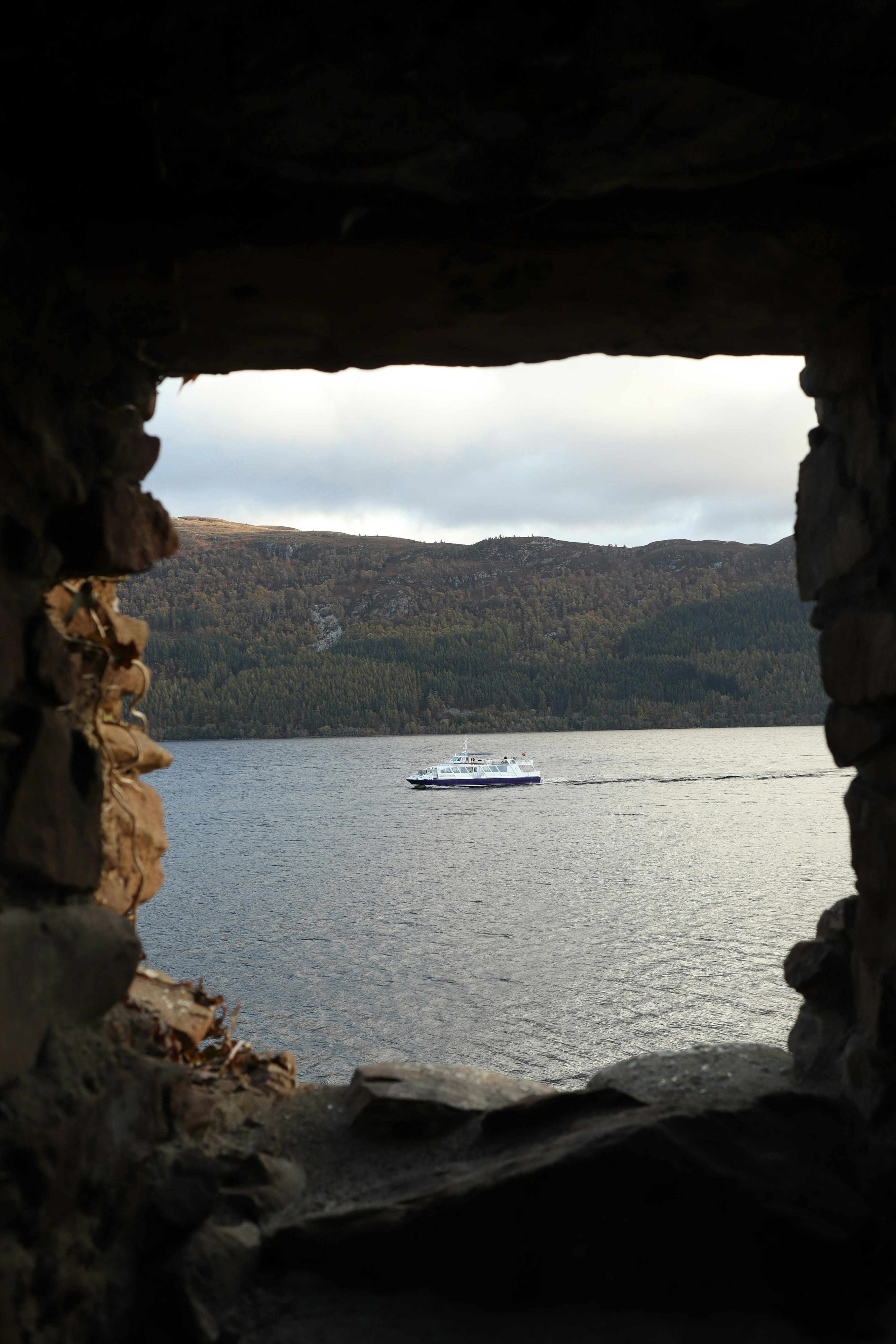 Boat on a Quiet Lake Framed by an Ancient Window