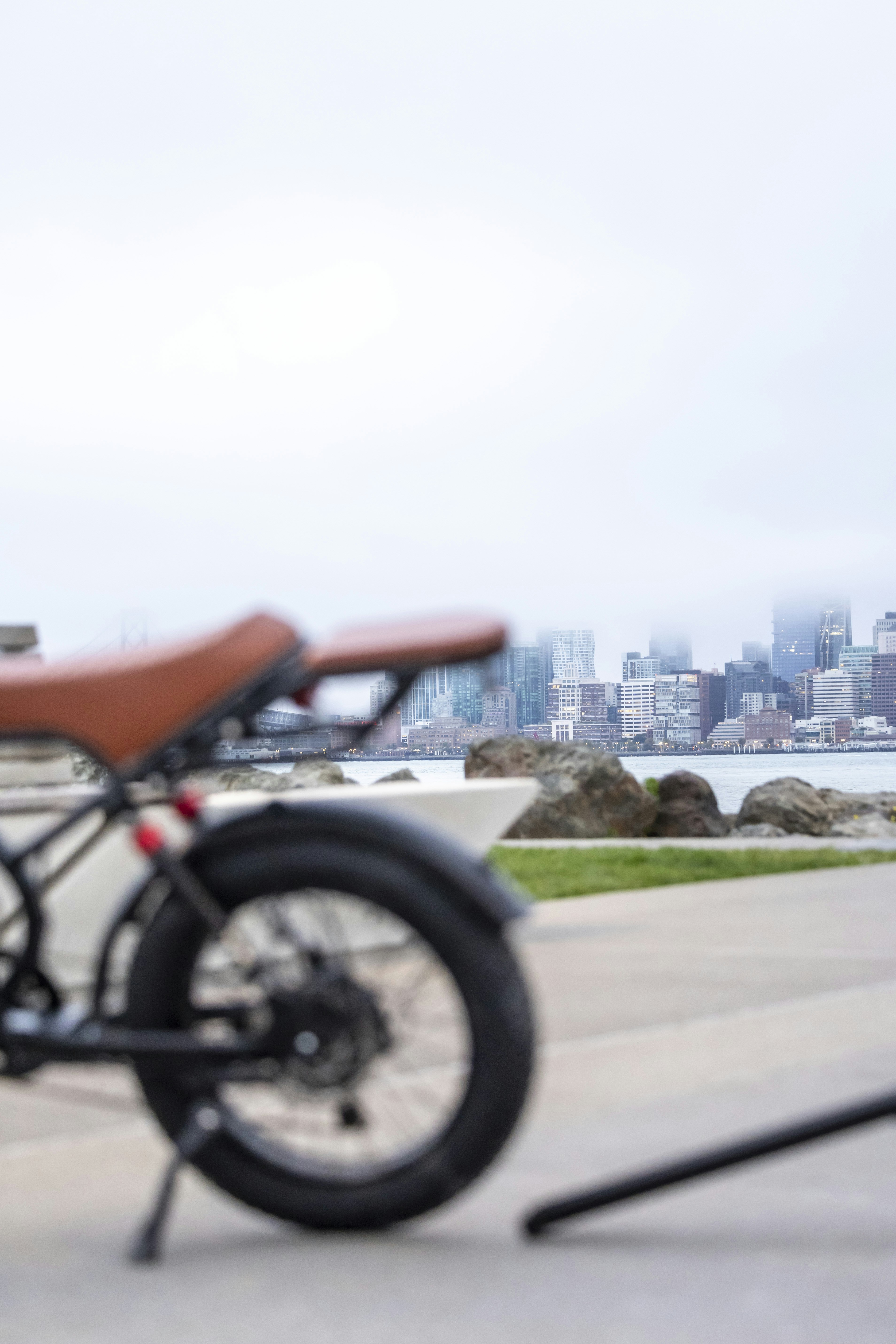 Low-angle Ride: bicycle foreground with cityscape in soft focus