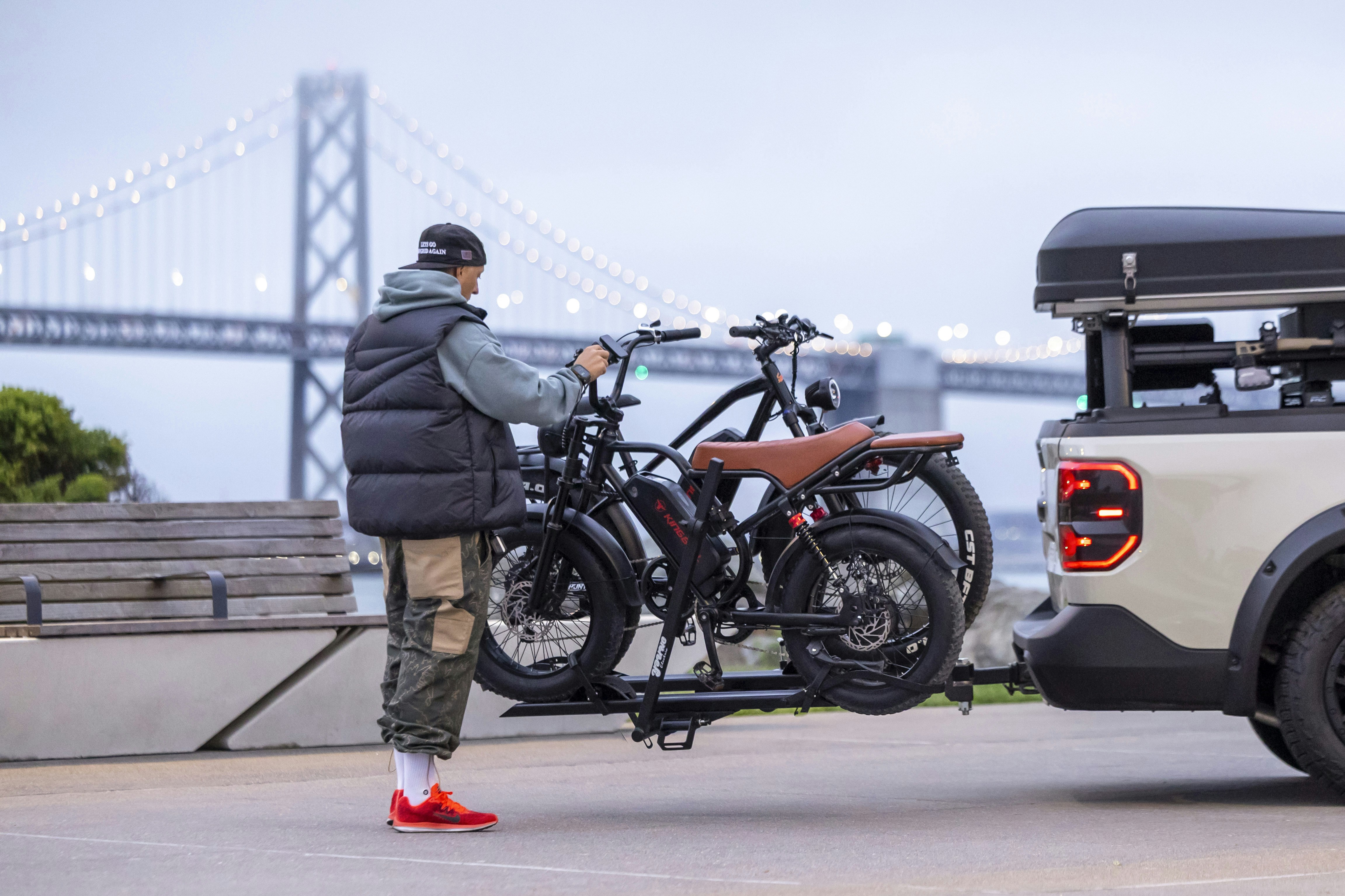 Cycle Duo: A Rider Prepares the Electric Bike for Departure by the River