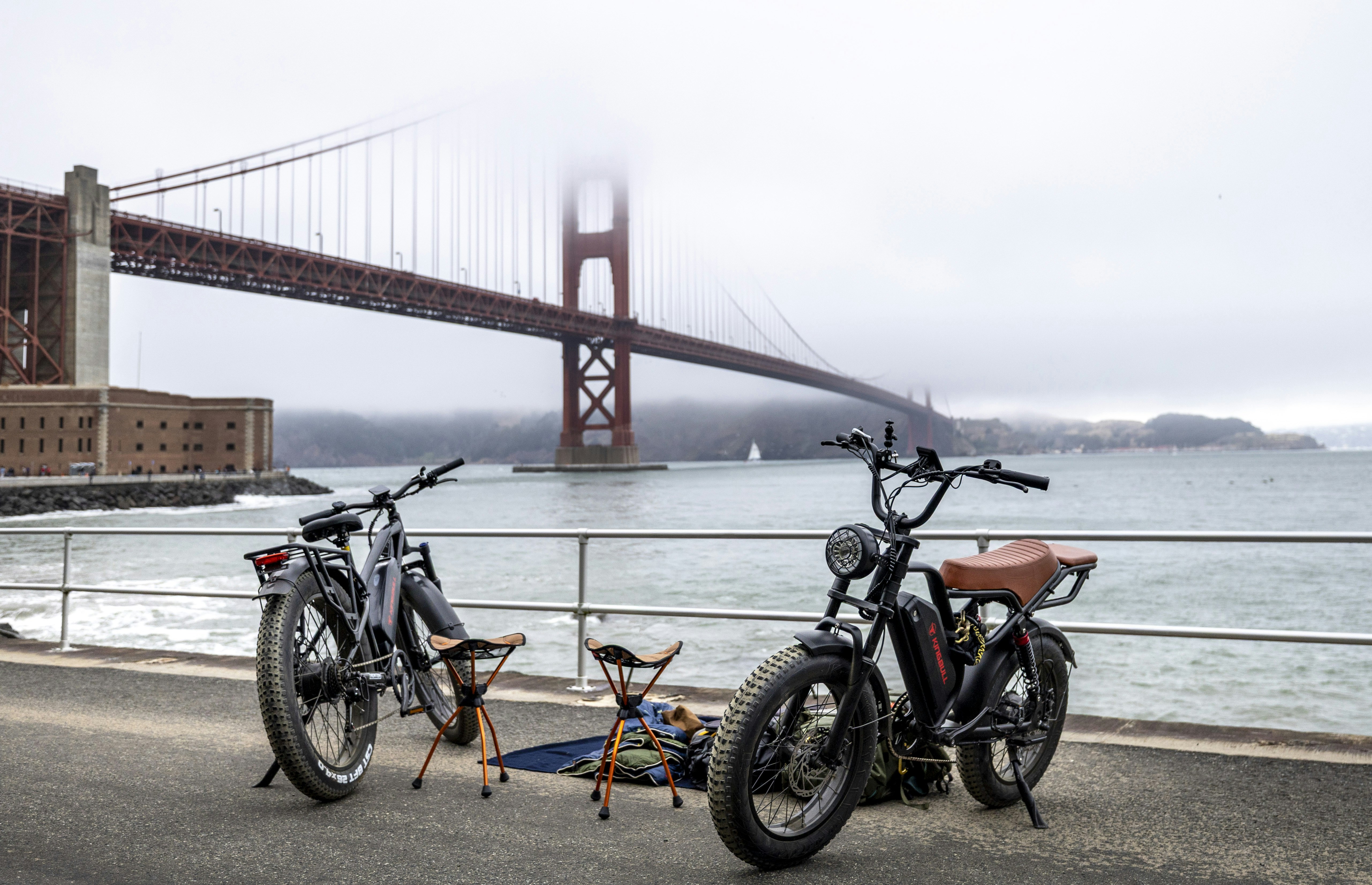 Two Vintage Motorbikes at the Foot of a Misty Golden Gate