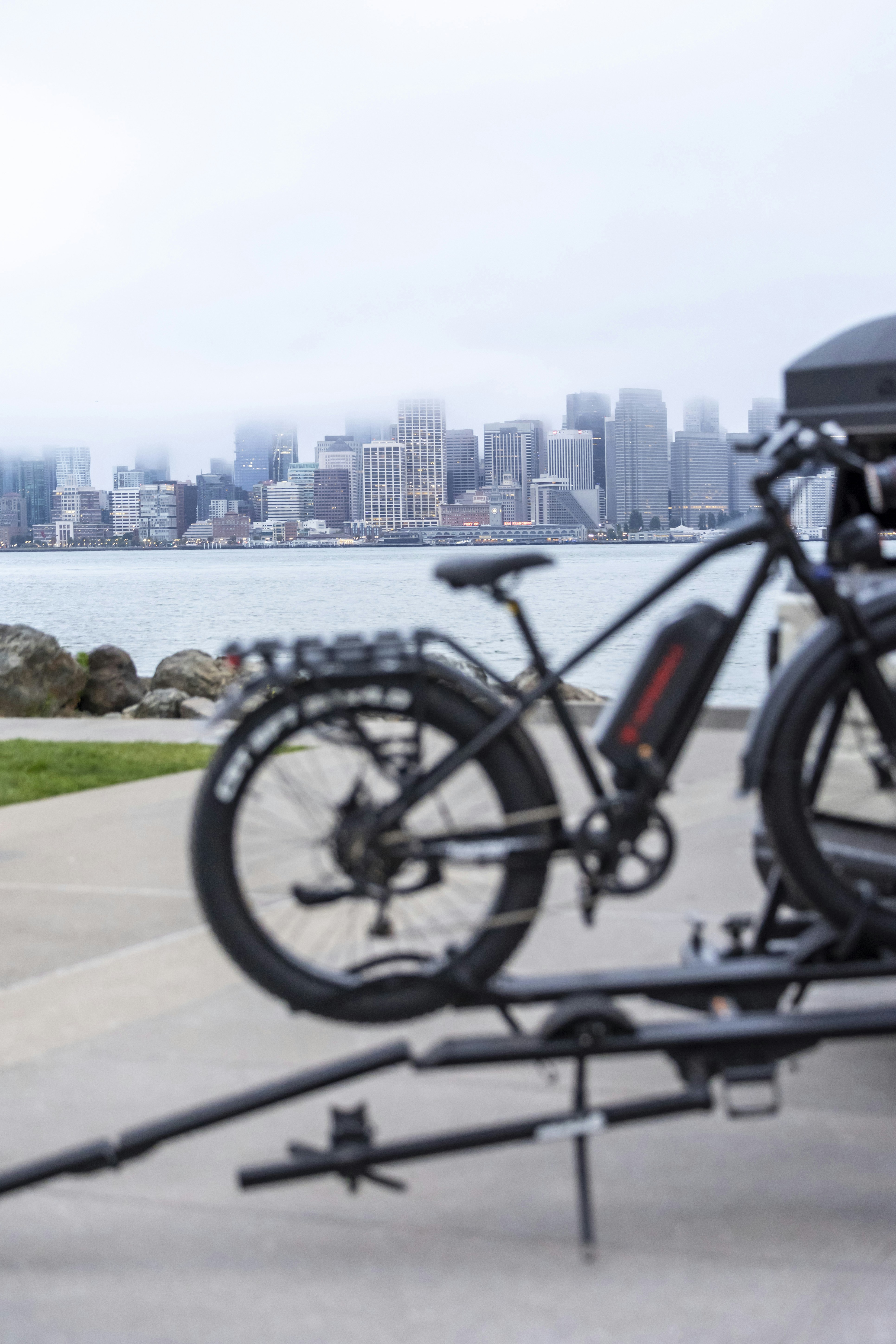 Bikes in the foreground, city skyline beyond the bay