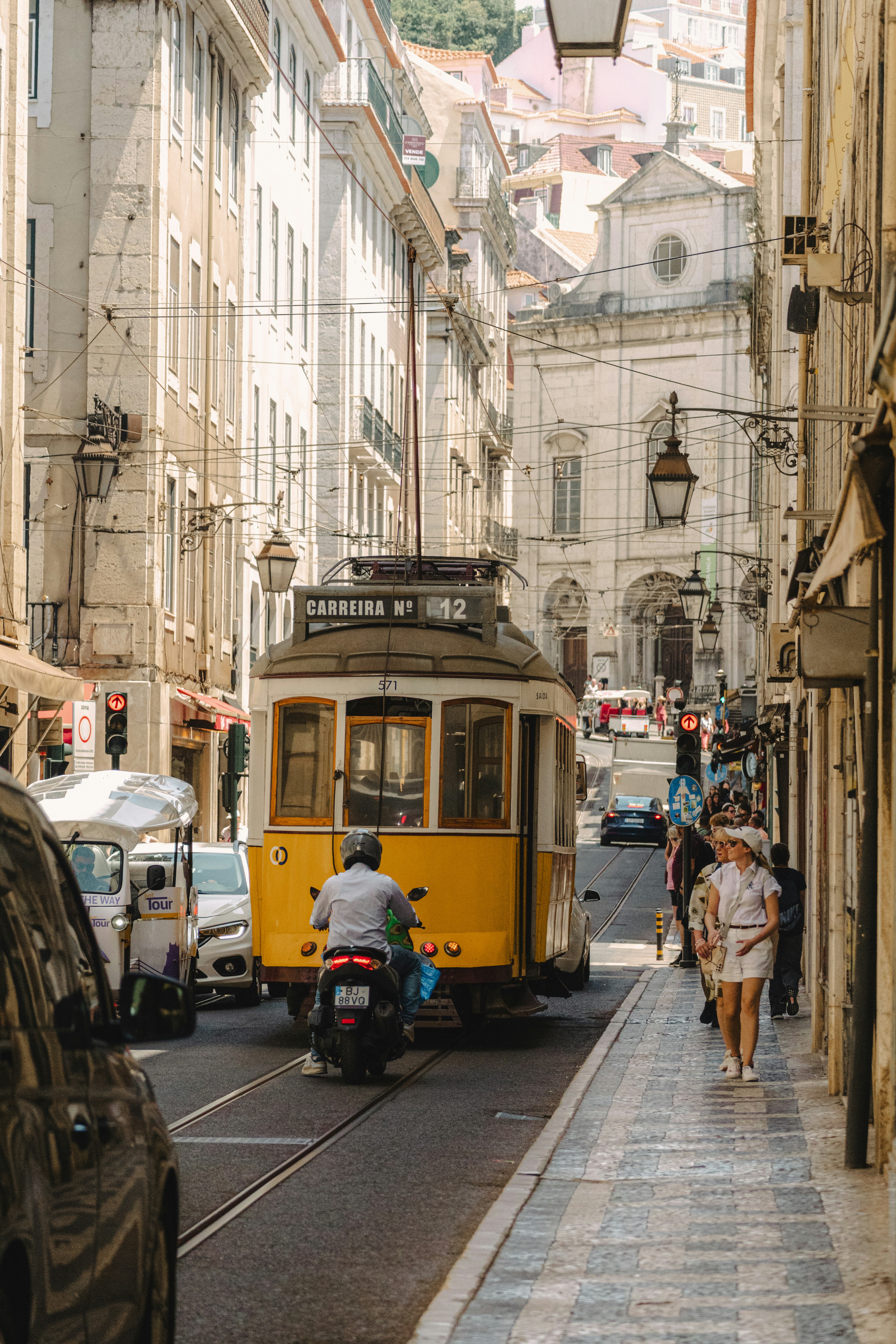Yellow Tram Crossing: A Charm of Lisbon's Hillside Street