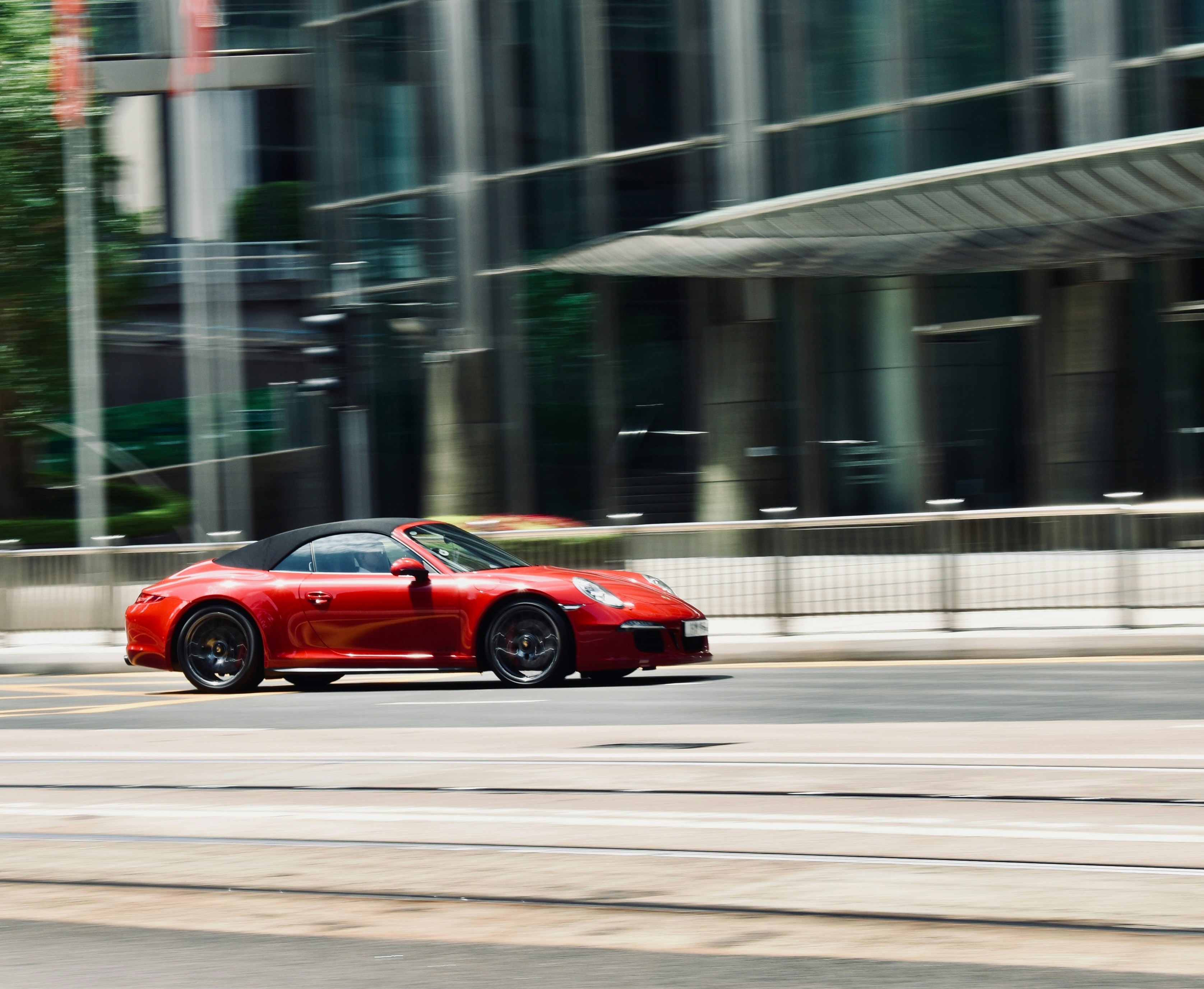 Red Roadster in Motion: a City Street Blur