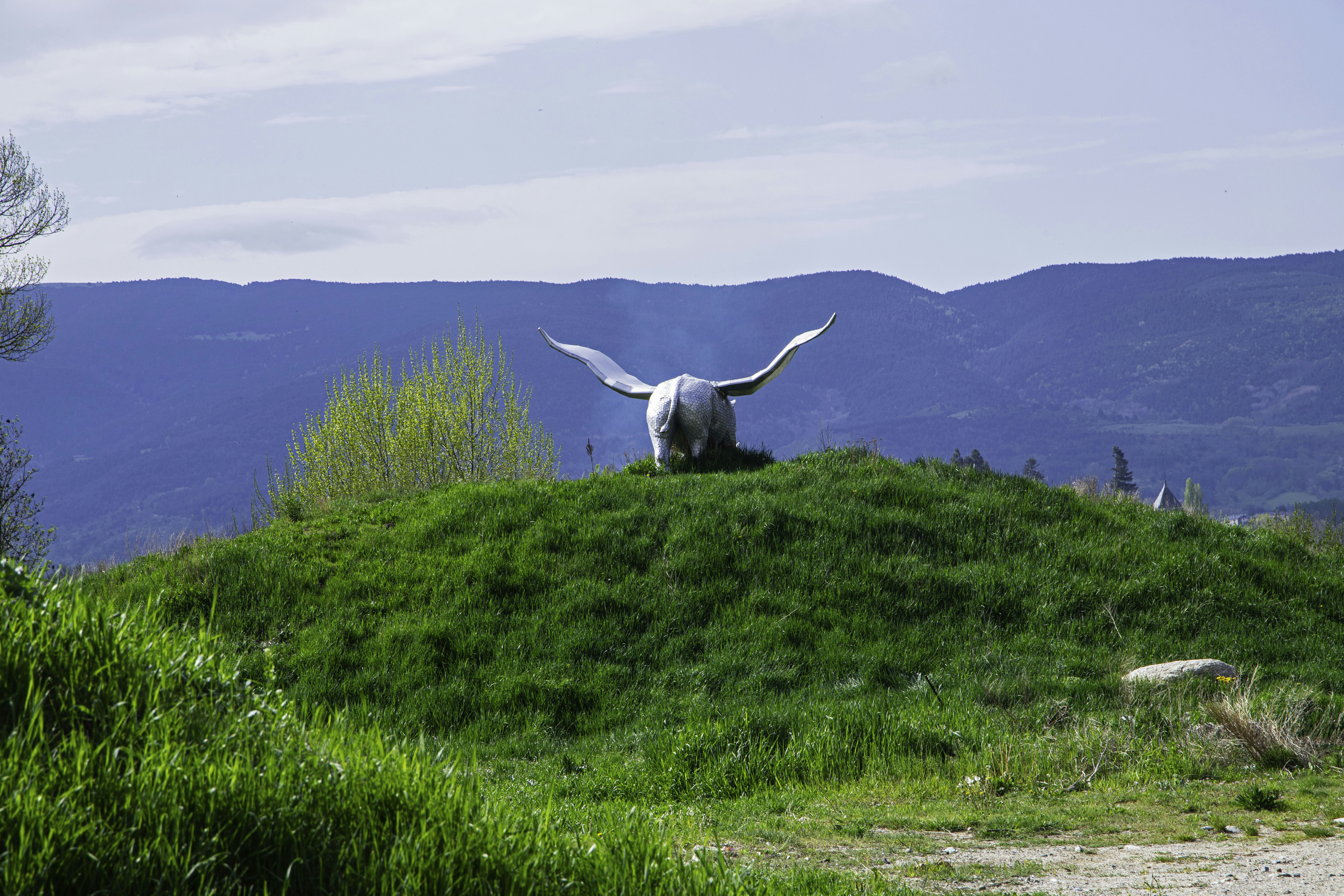 Highland statue with outstretched wings on emerald mound