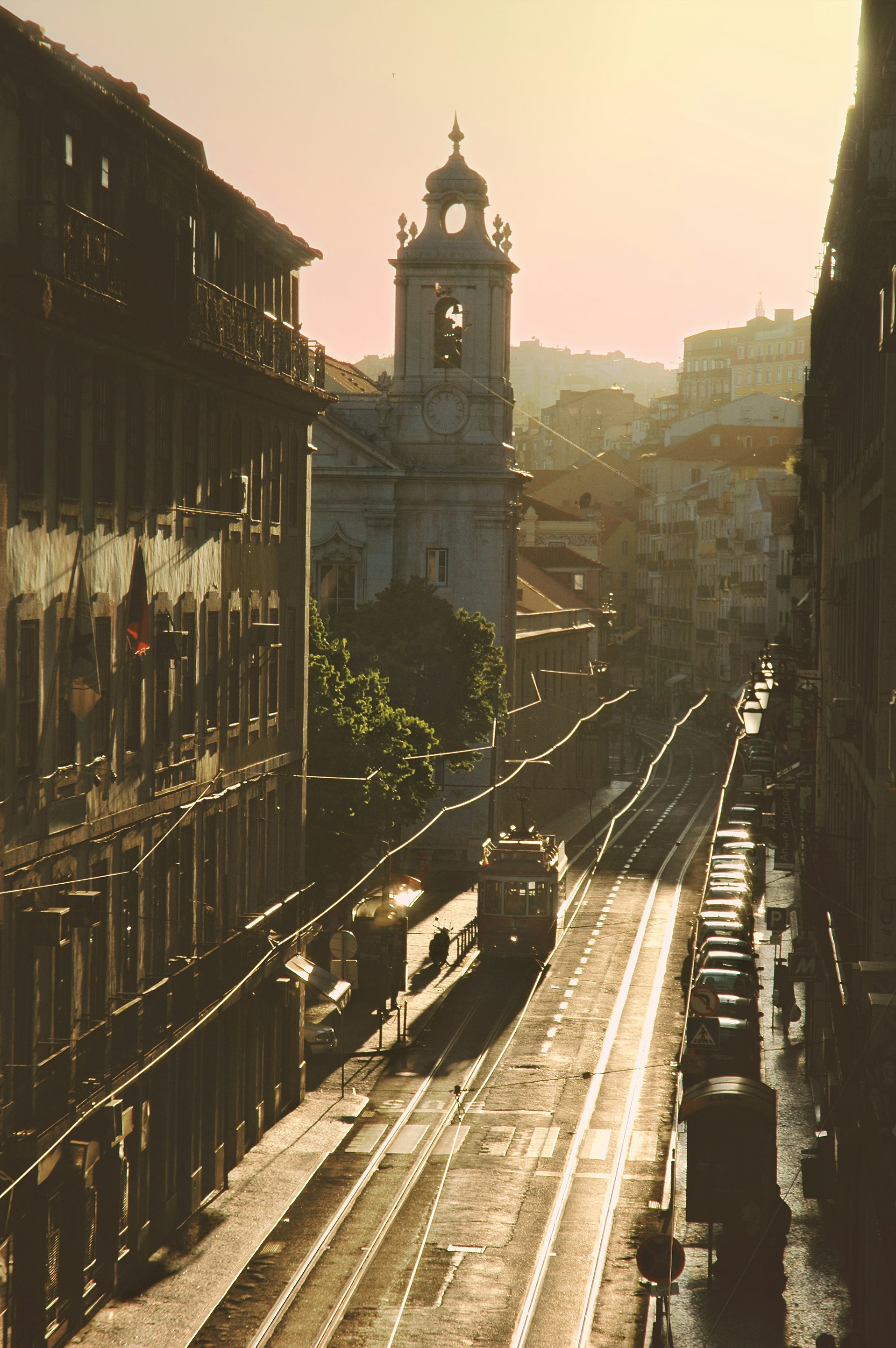 Sunlit Rua Nova: A Golden Hour Transit Beneath Clock Tower