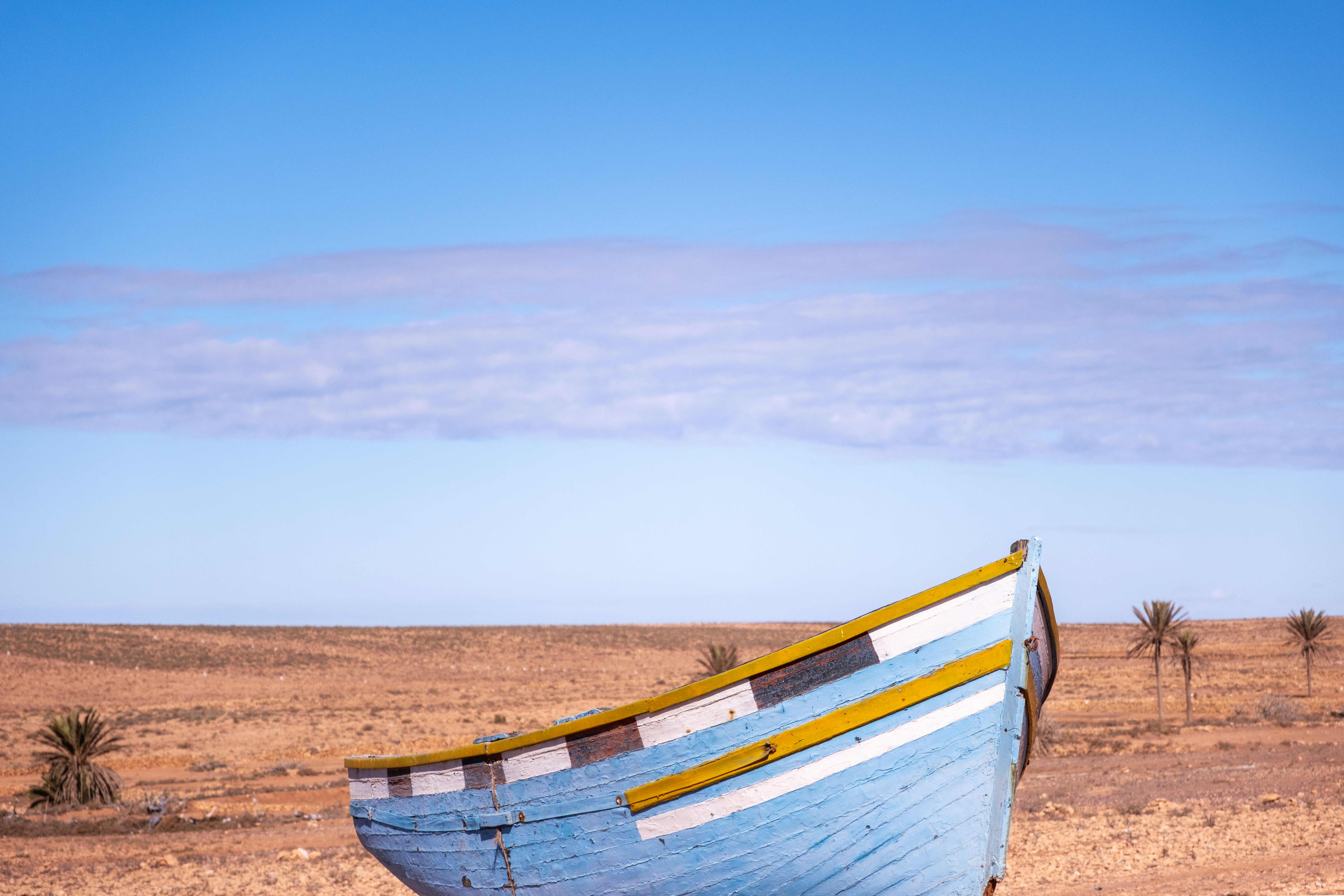 Pastel Horizon: A Weathered Docking Boat on Arid Plains