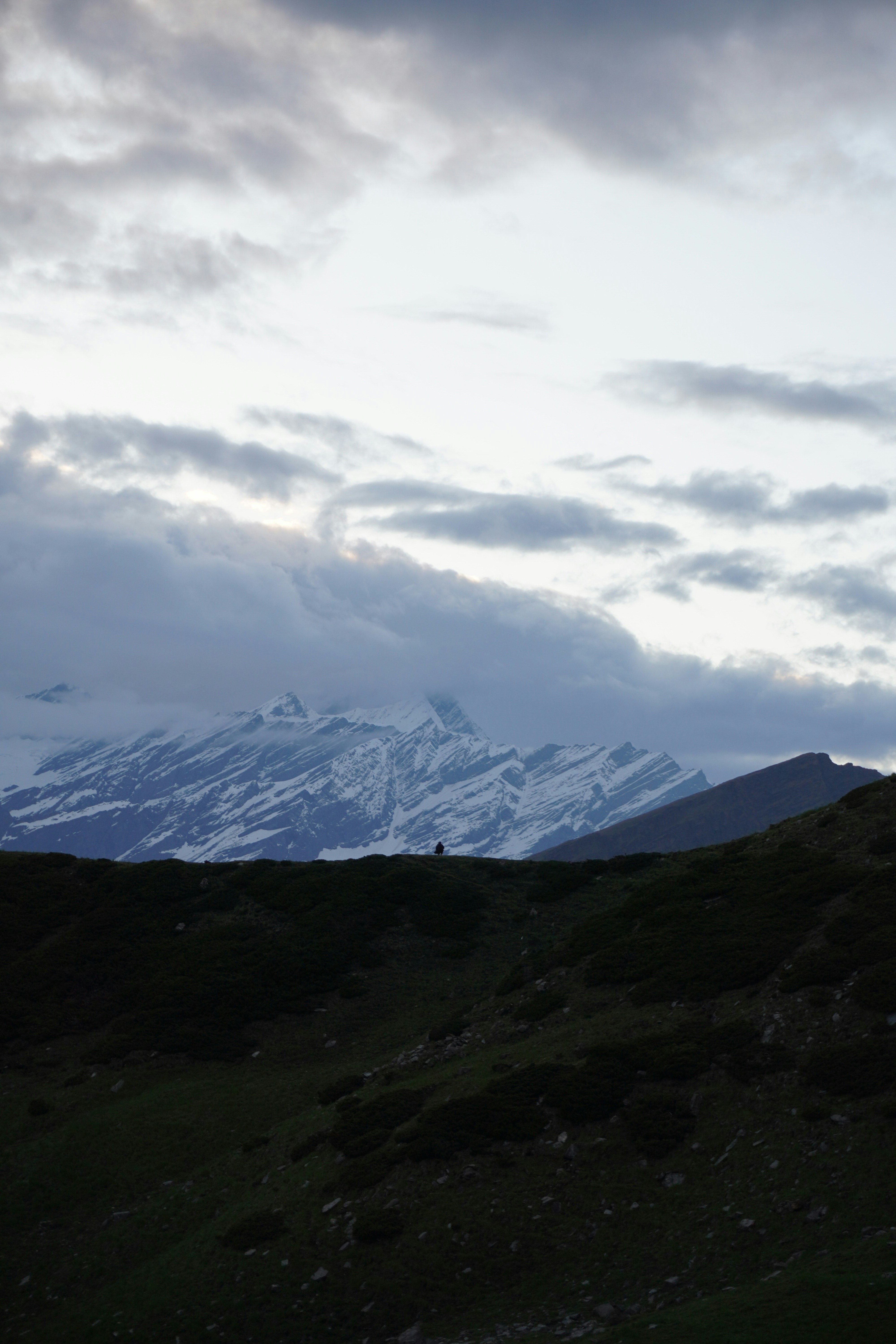 Snow-kissed Ridge under Layered Clouds