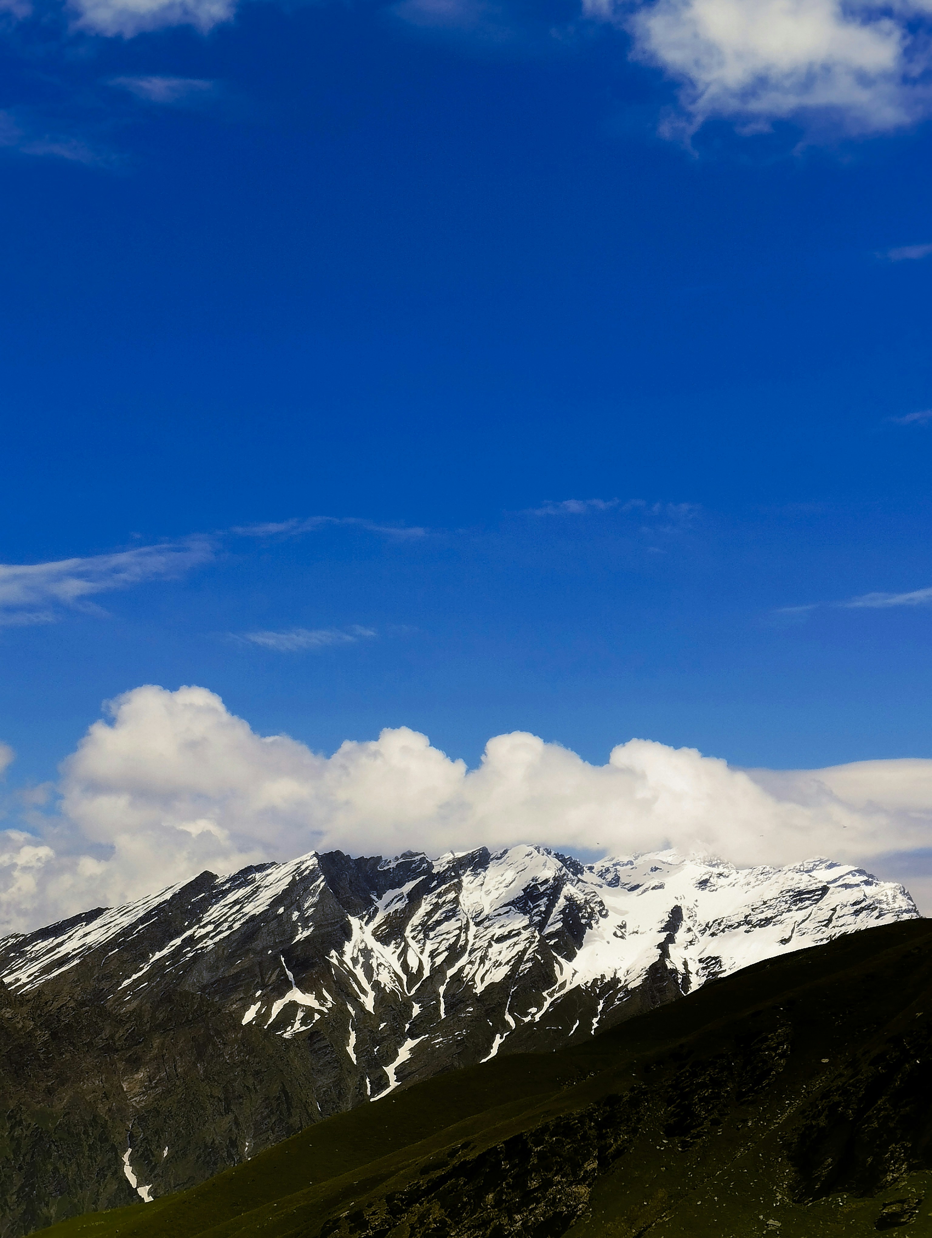 Snow-covered peaks beneath a vivid blue sky.