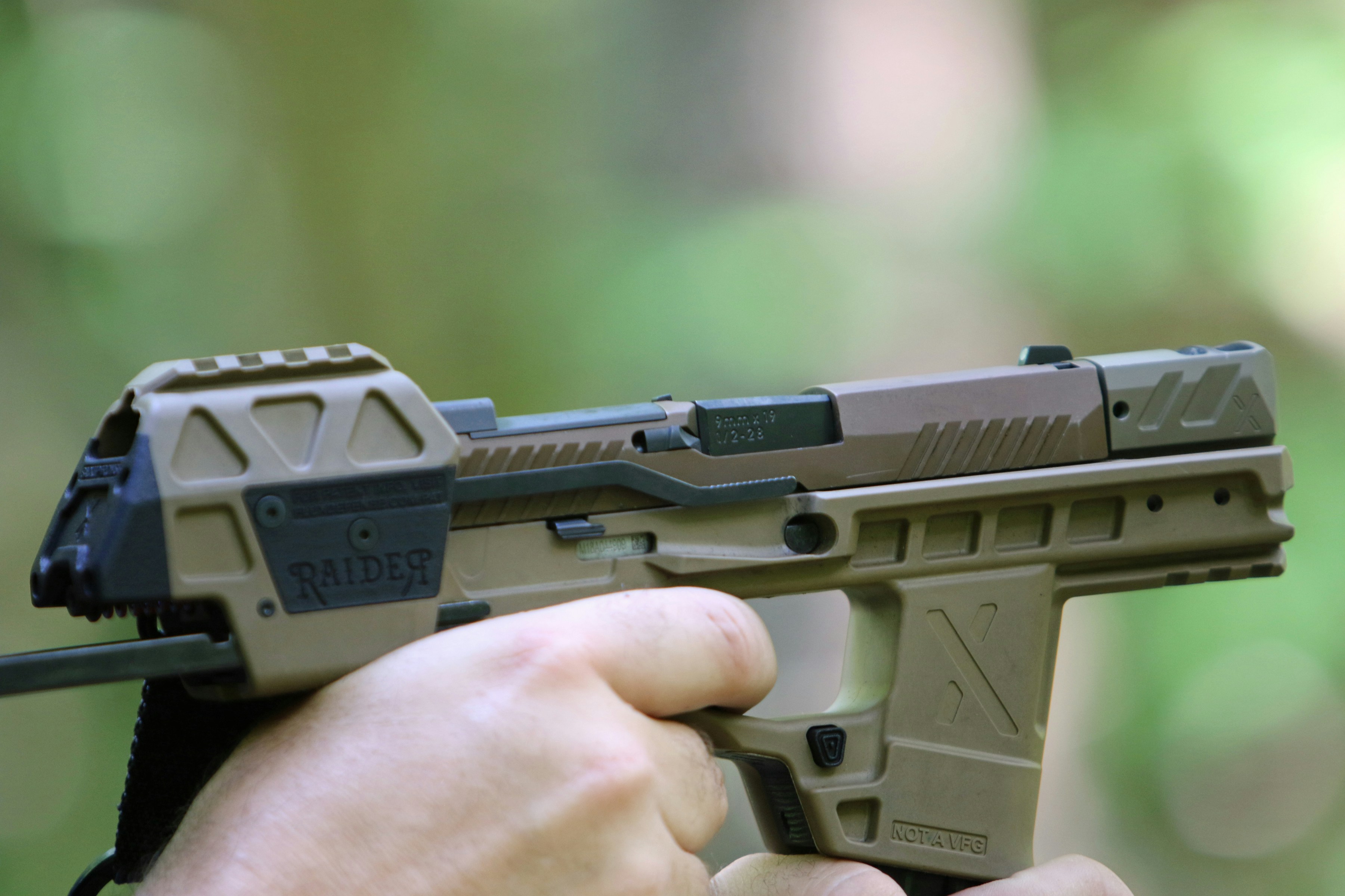 Desaturated Defender: Close-up of a Tactical Handgun in Focus