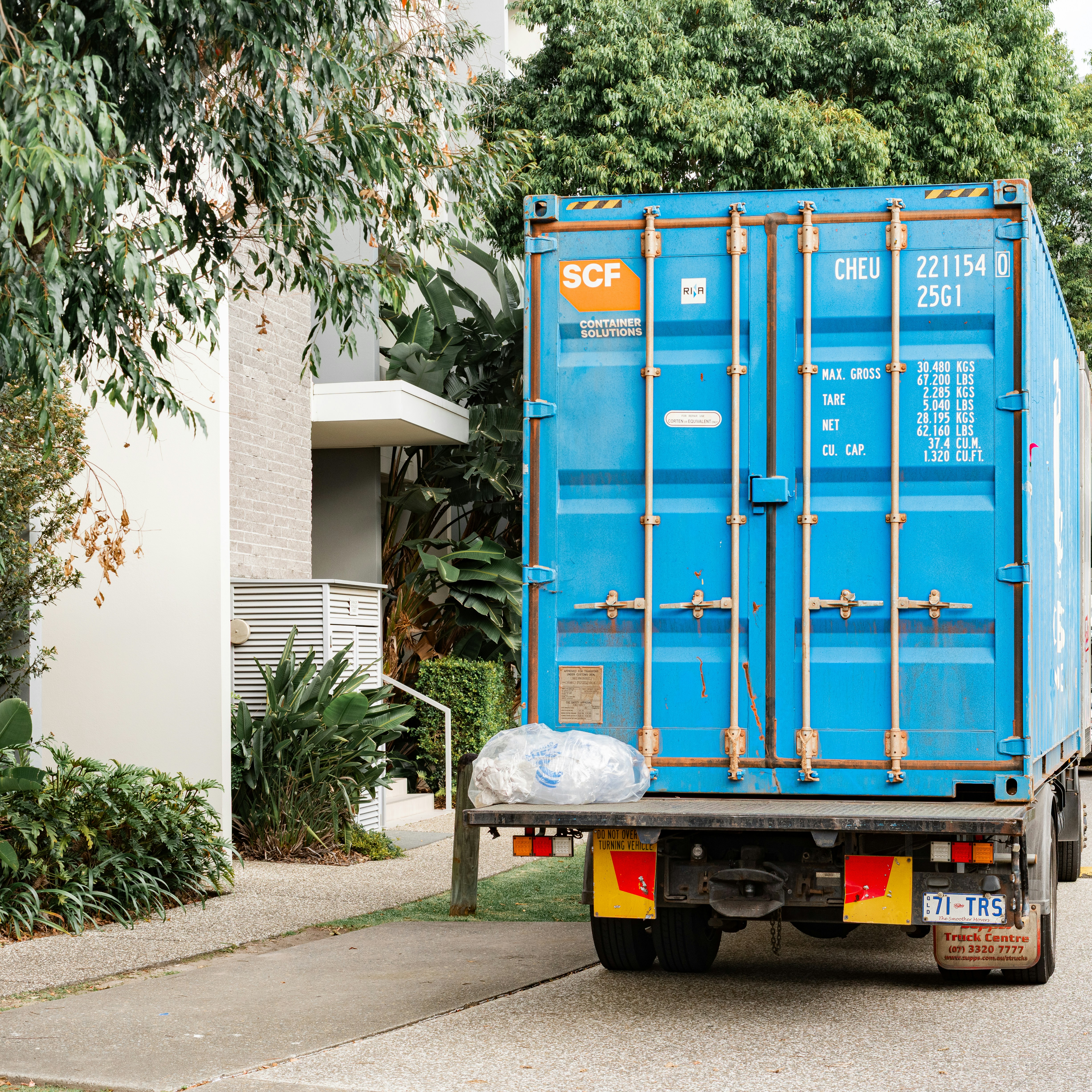 Blue Container Truck at a Residential Street