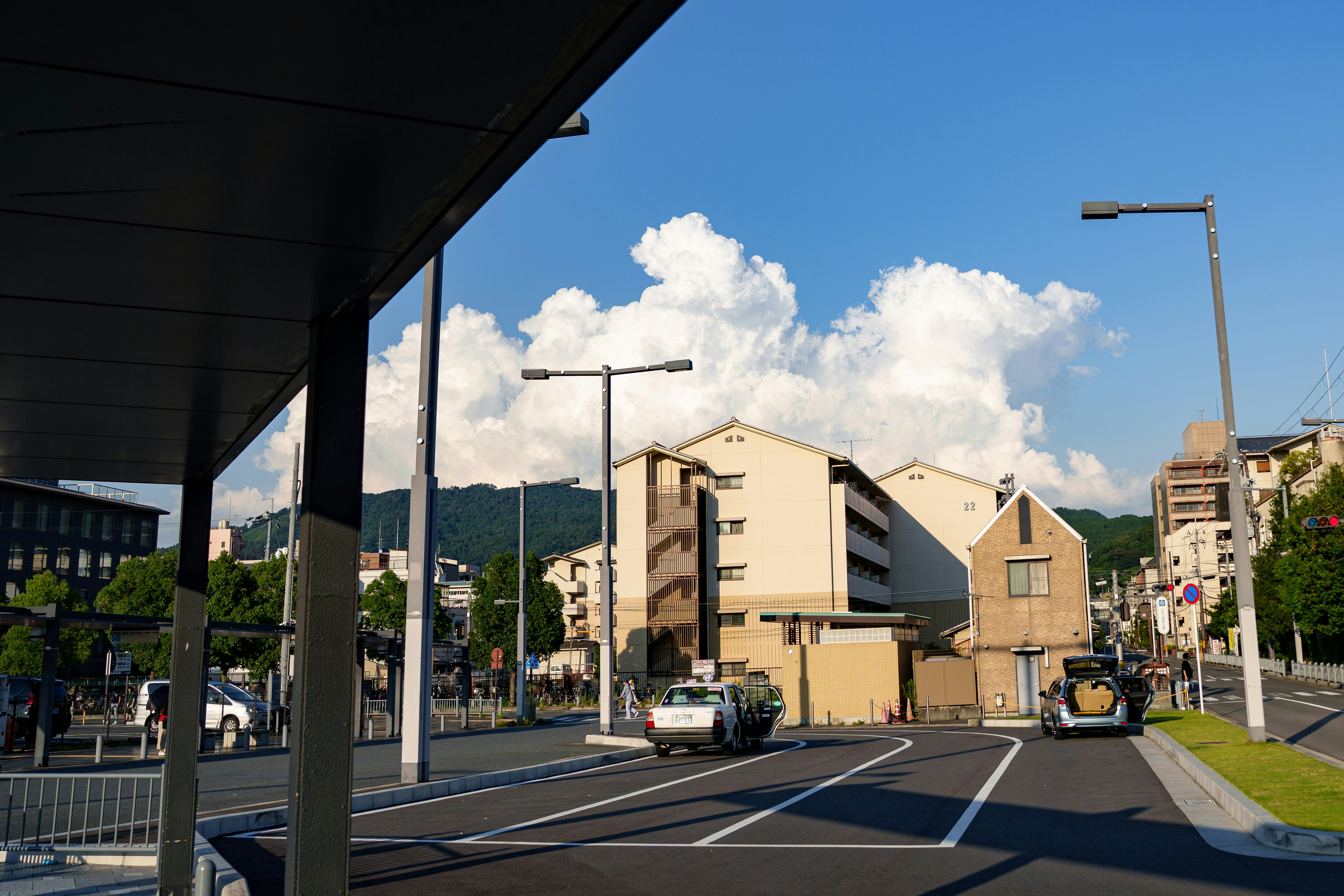 Sunlit Street Corridor Framed by Modern Facades
