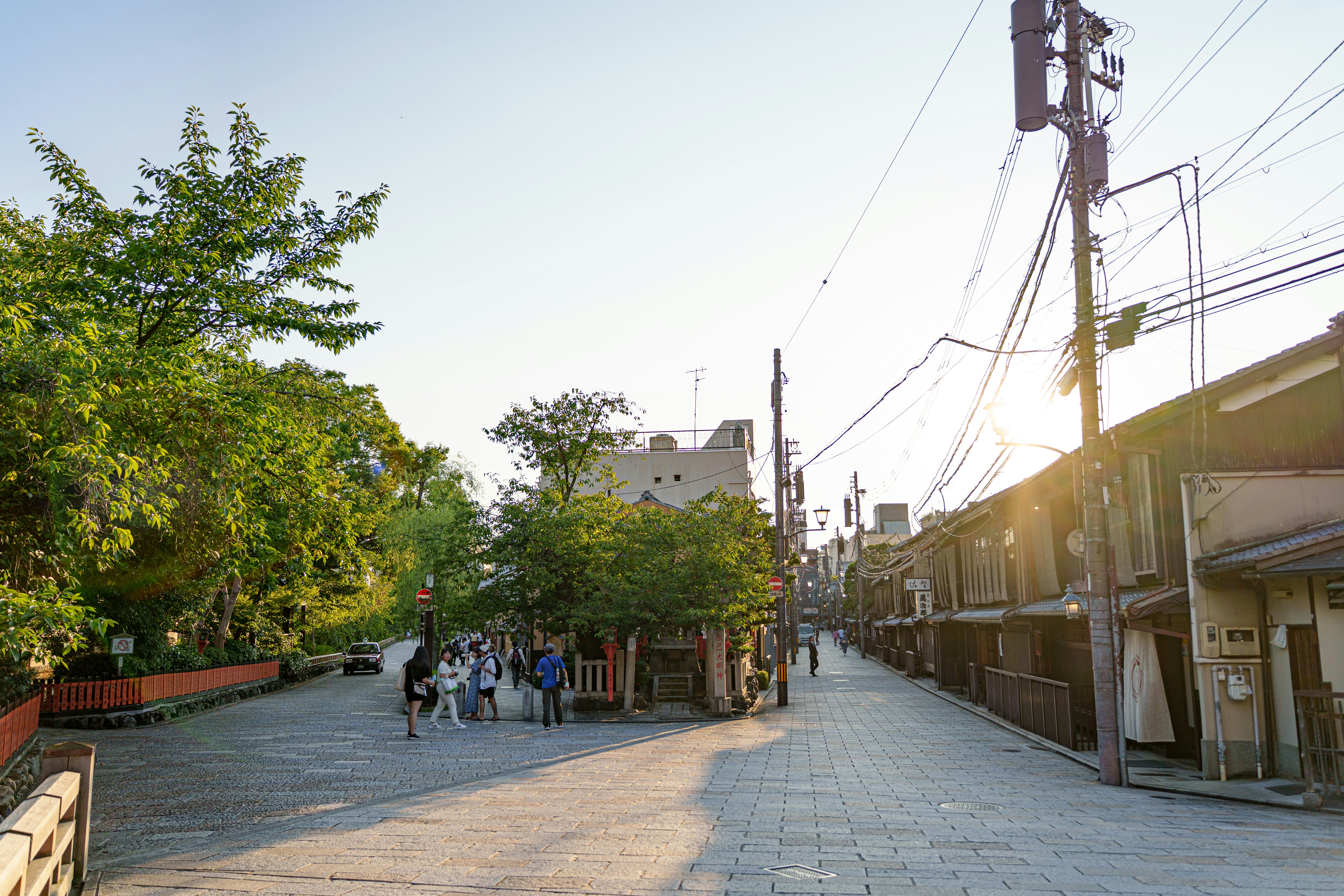 Sunlit Plaza: A Quiet Street Gathering Beneath An Open Sky