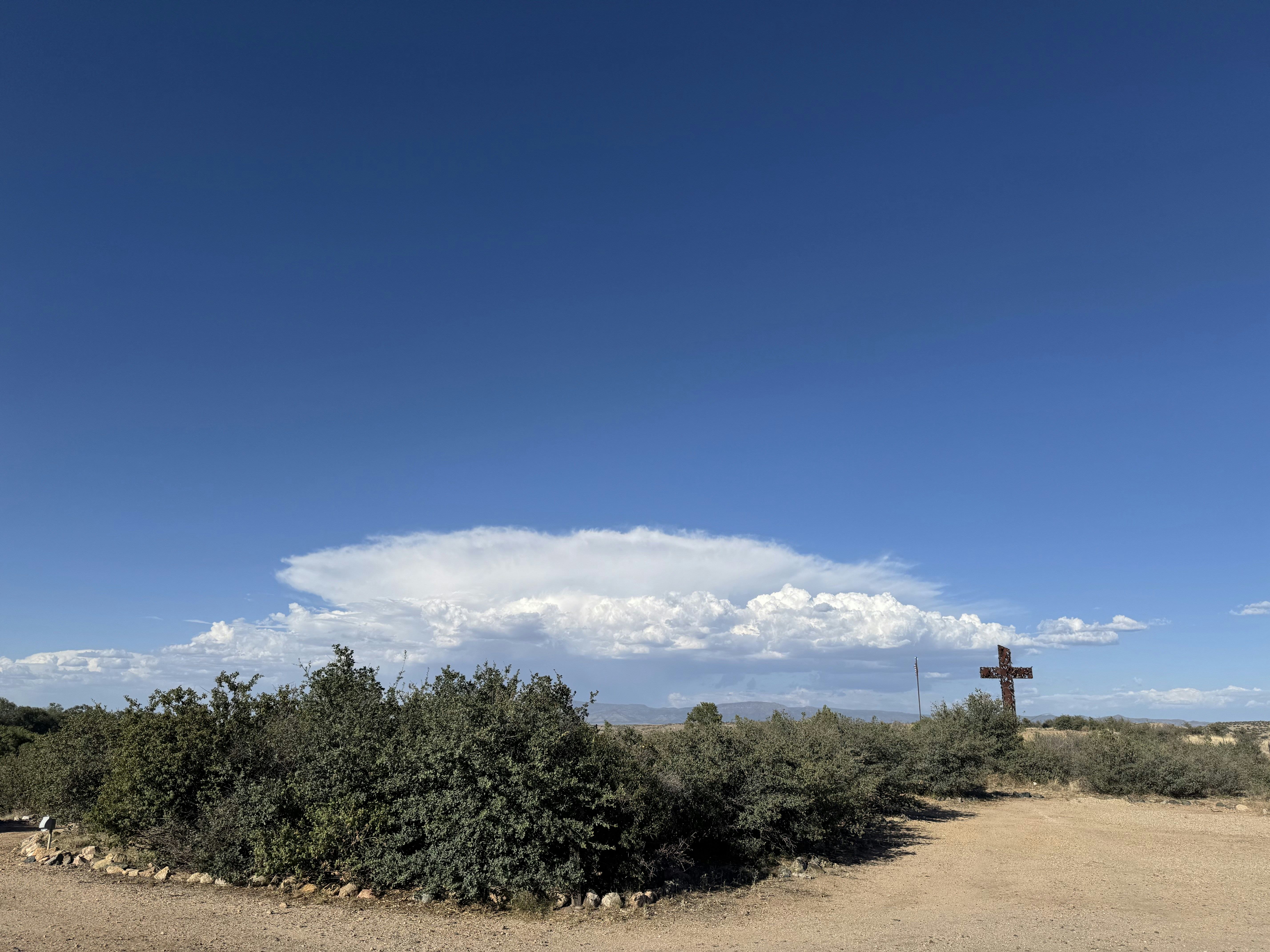 Desert Horizon with Low Scrub and Cross Monument