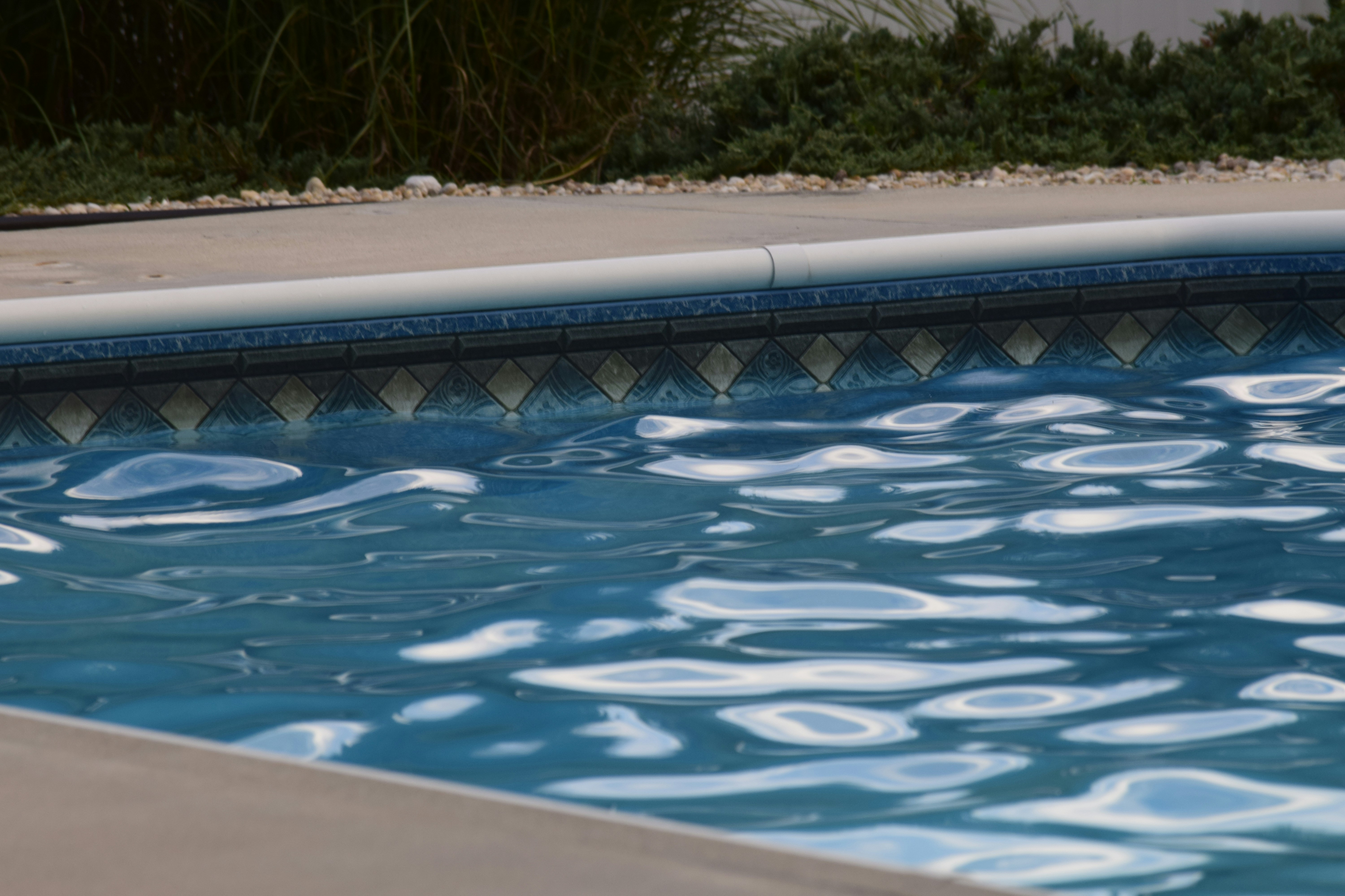 Rippled Quiet: Edge of a Pool with Gentle Reflections