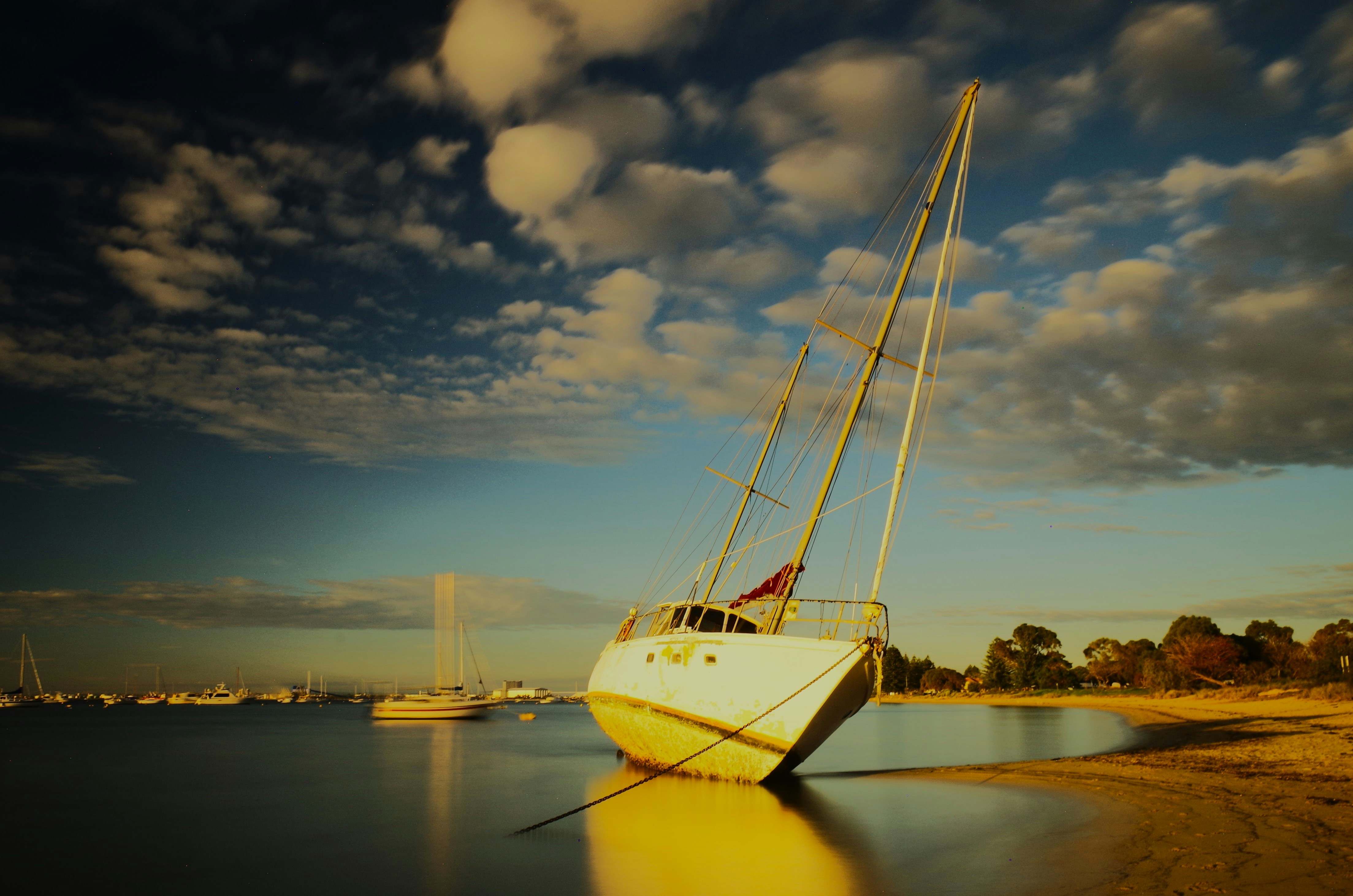 Leaning Vessel at the Waterline Under Evening Sky