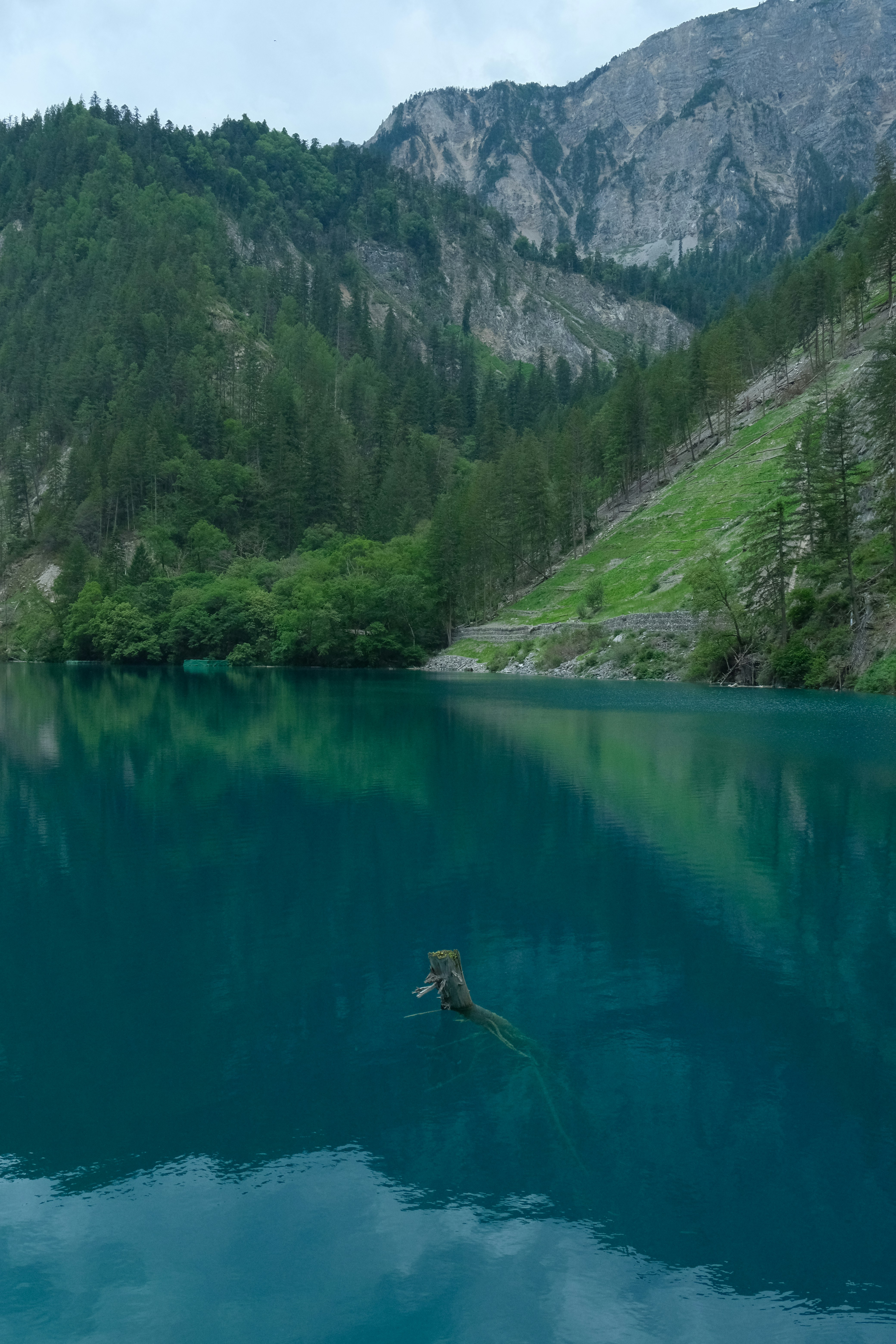 Azure Mirror: Mountain Crest Reflected on a Tranquil Alpine Lake