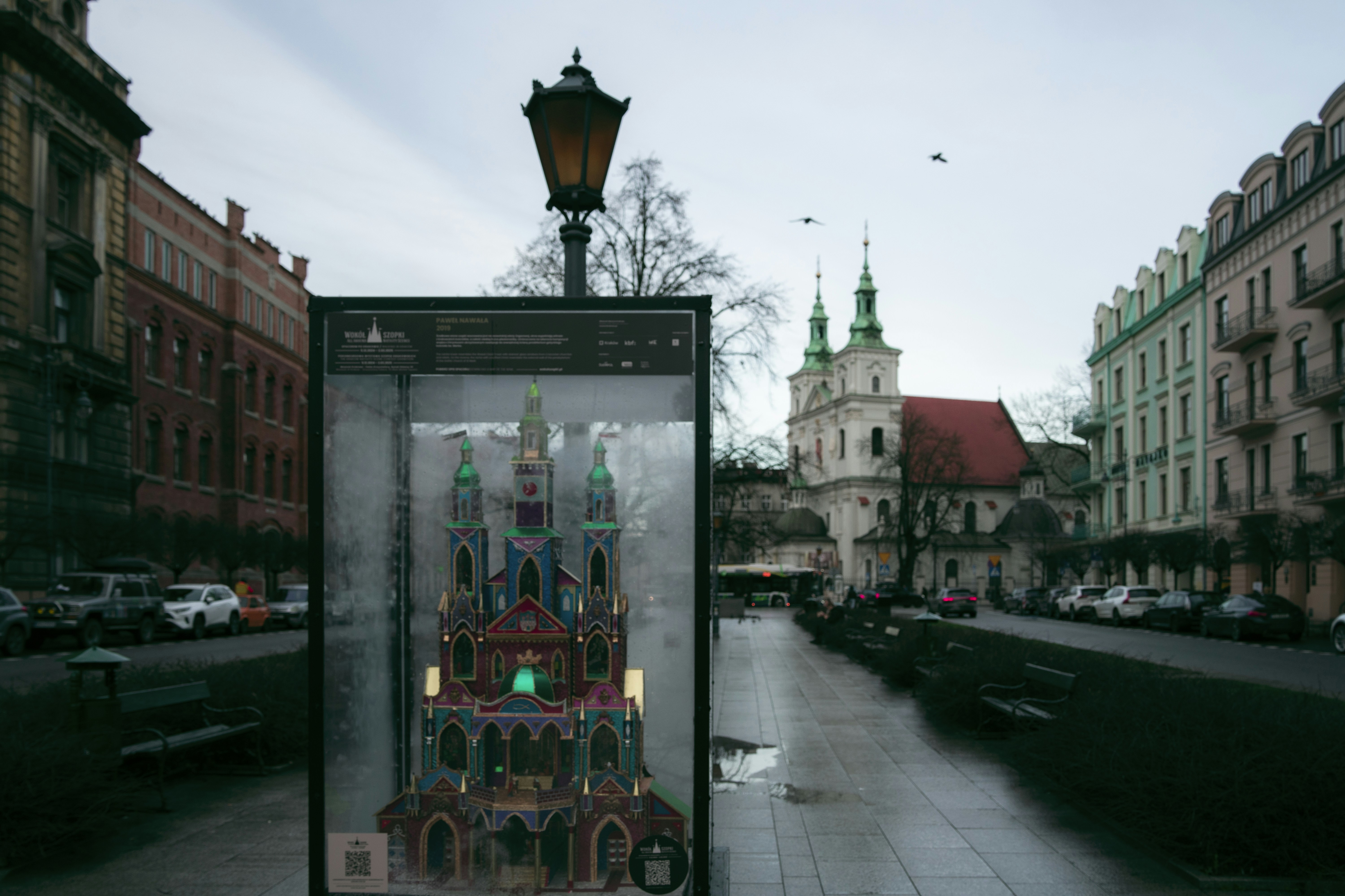 Ornate Church Ad Poster at a Rainy City Walkway