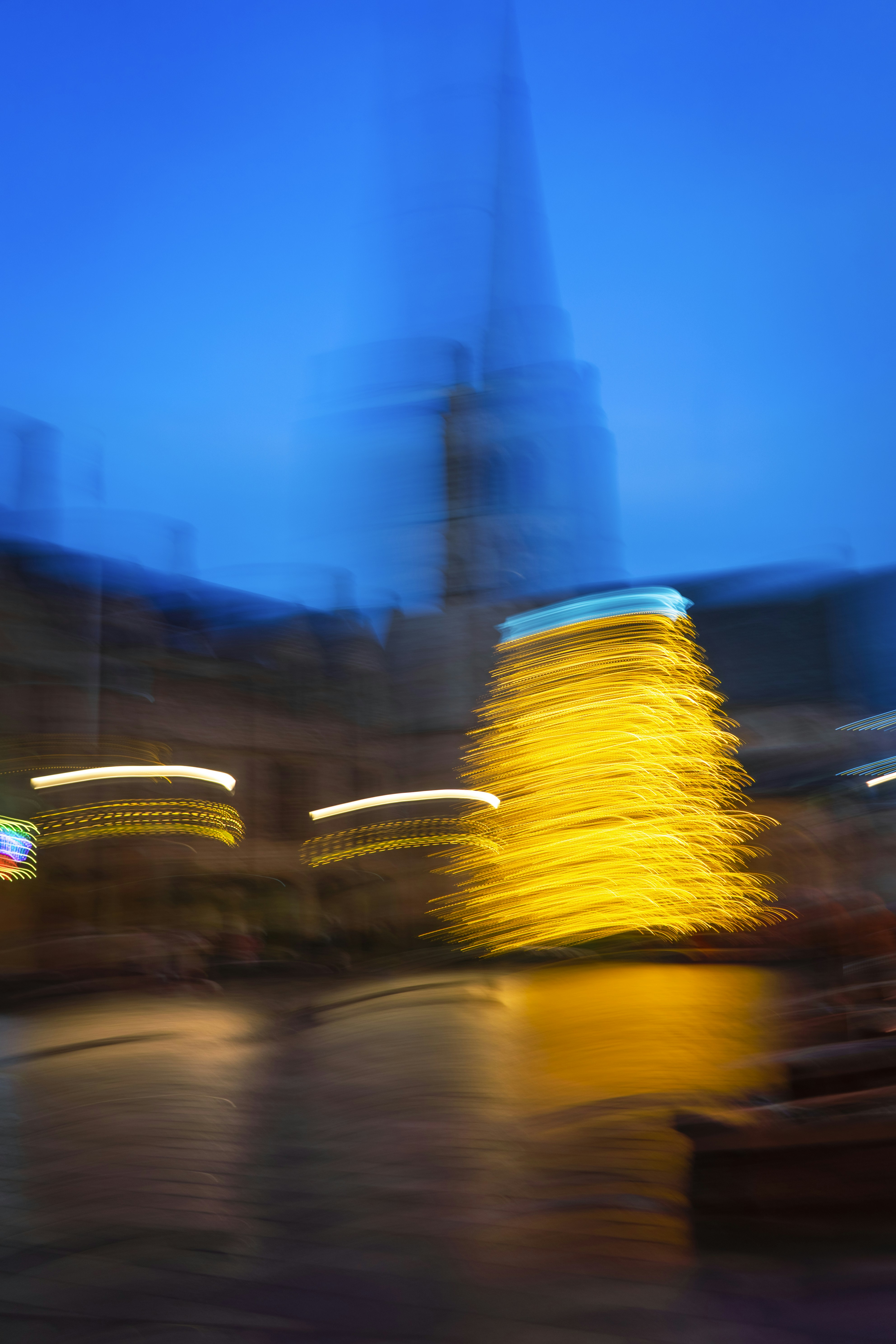 Glowing Carousel of Motion in a Blue Hour Square