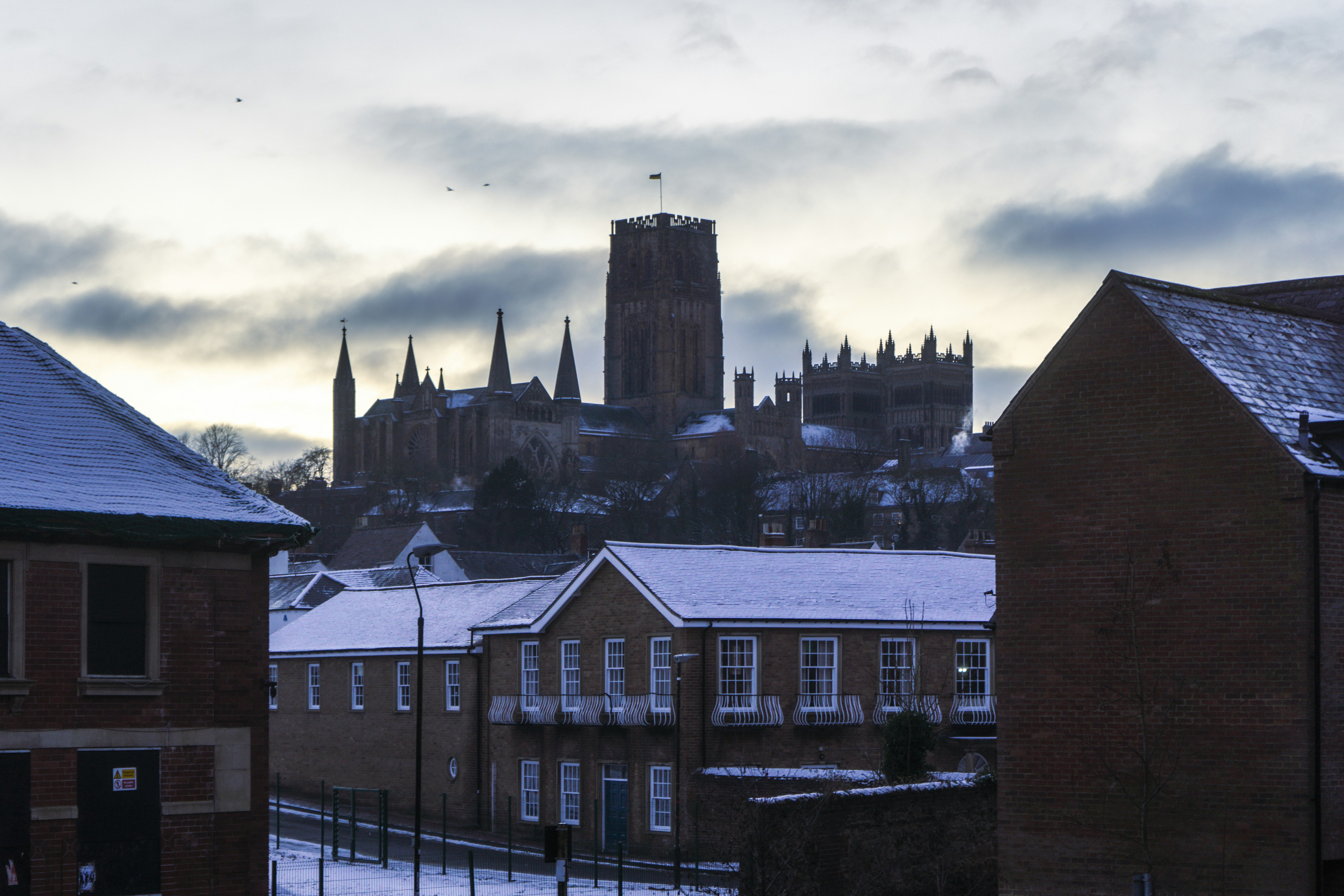 Twin Towers and Snow-Capped Rooftops: Evening Reach Across the City