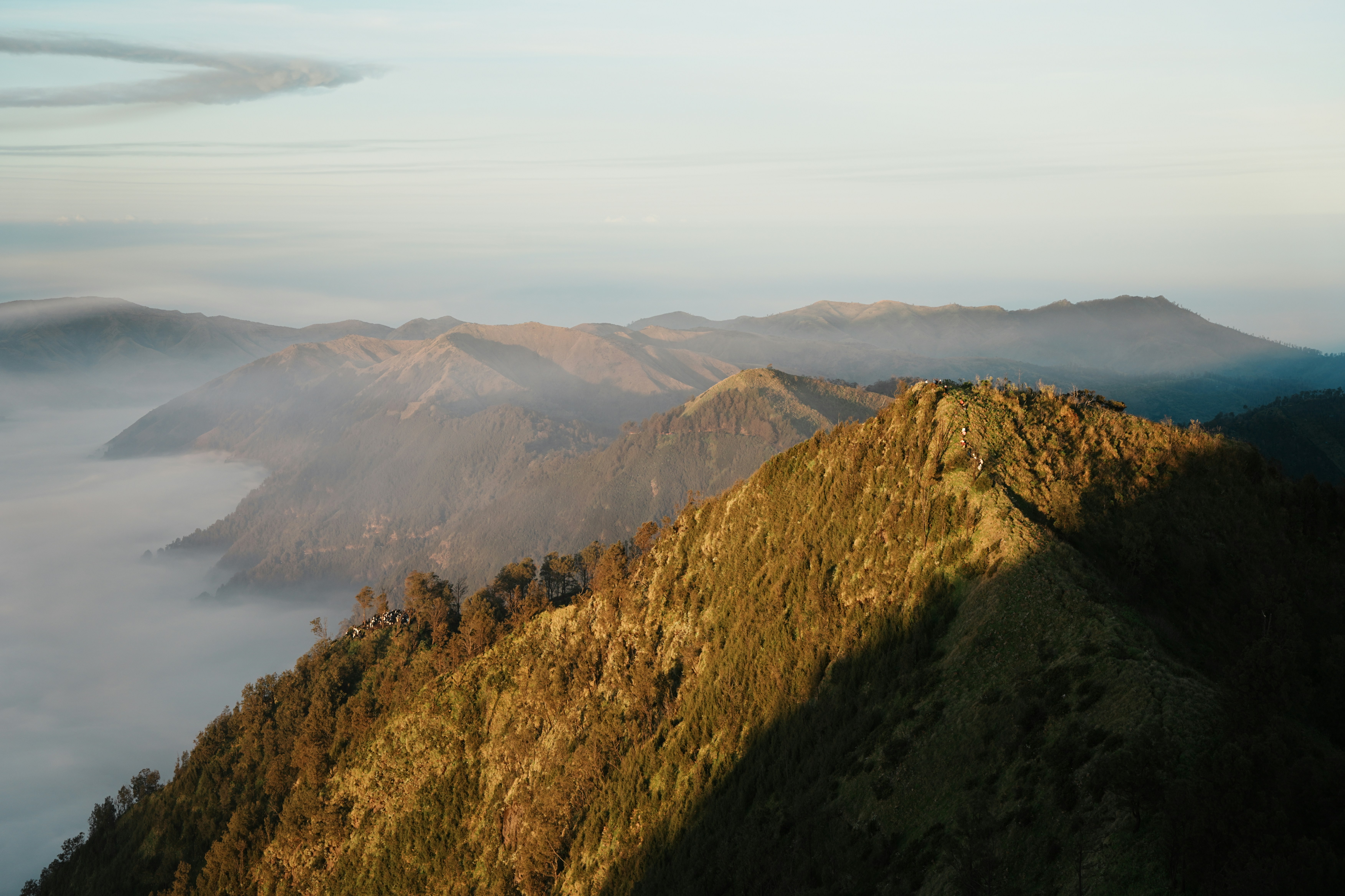 Golden Ridge at Dawn: Sunlit Crest Over Misty Valleys