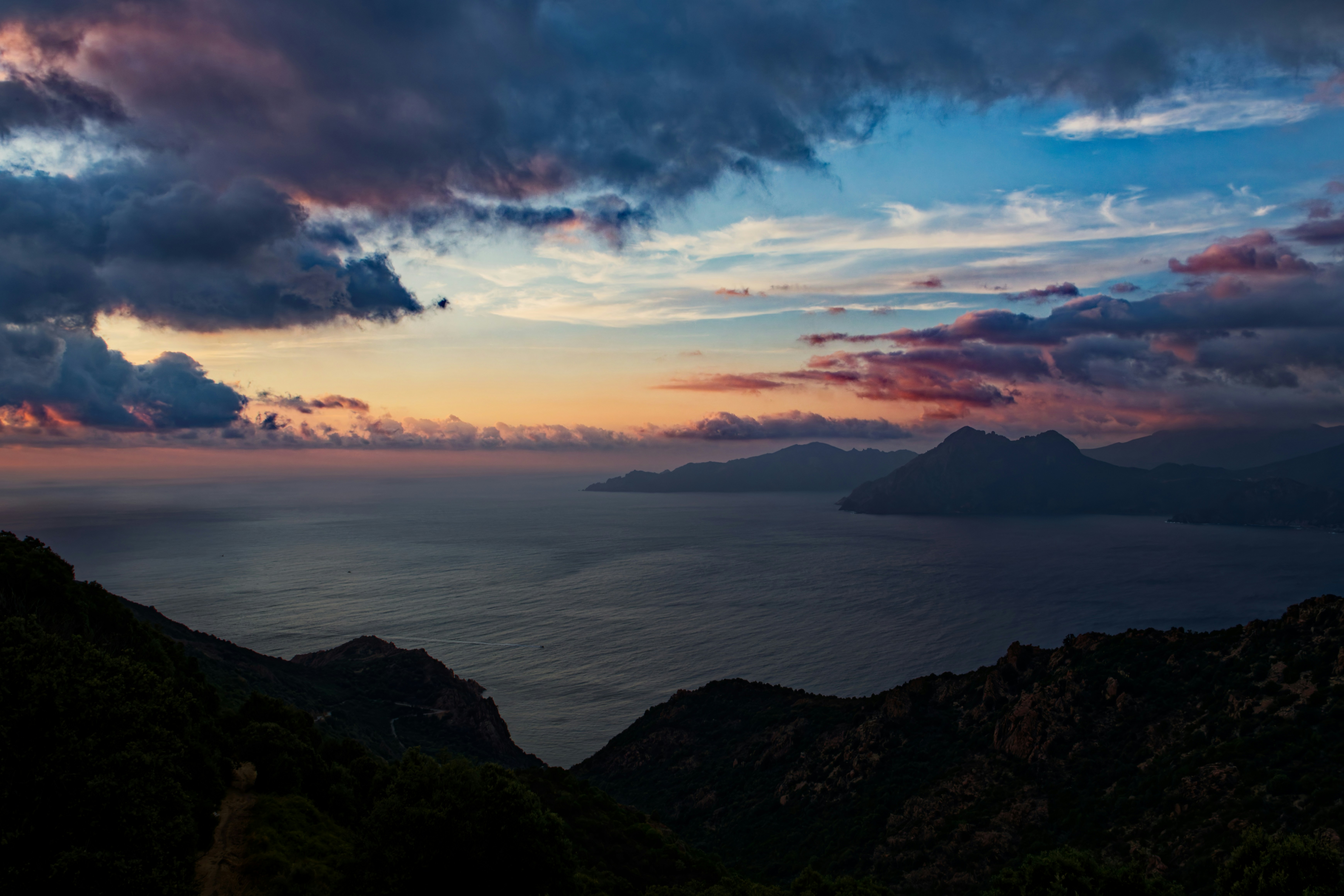 Sunset Over Serene Inlet: A Windswept Coastal Vantage