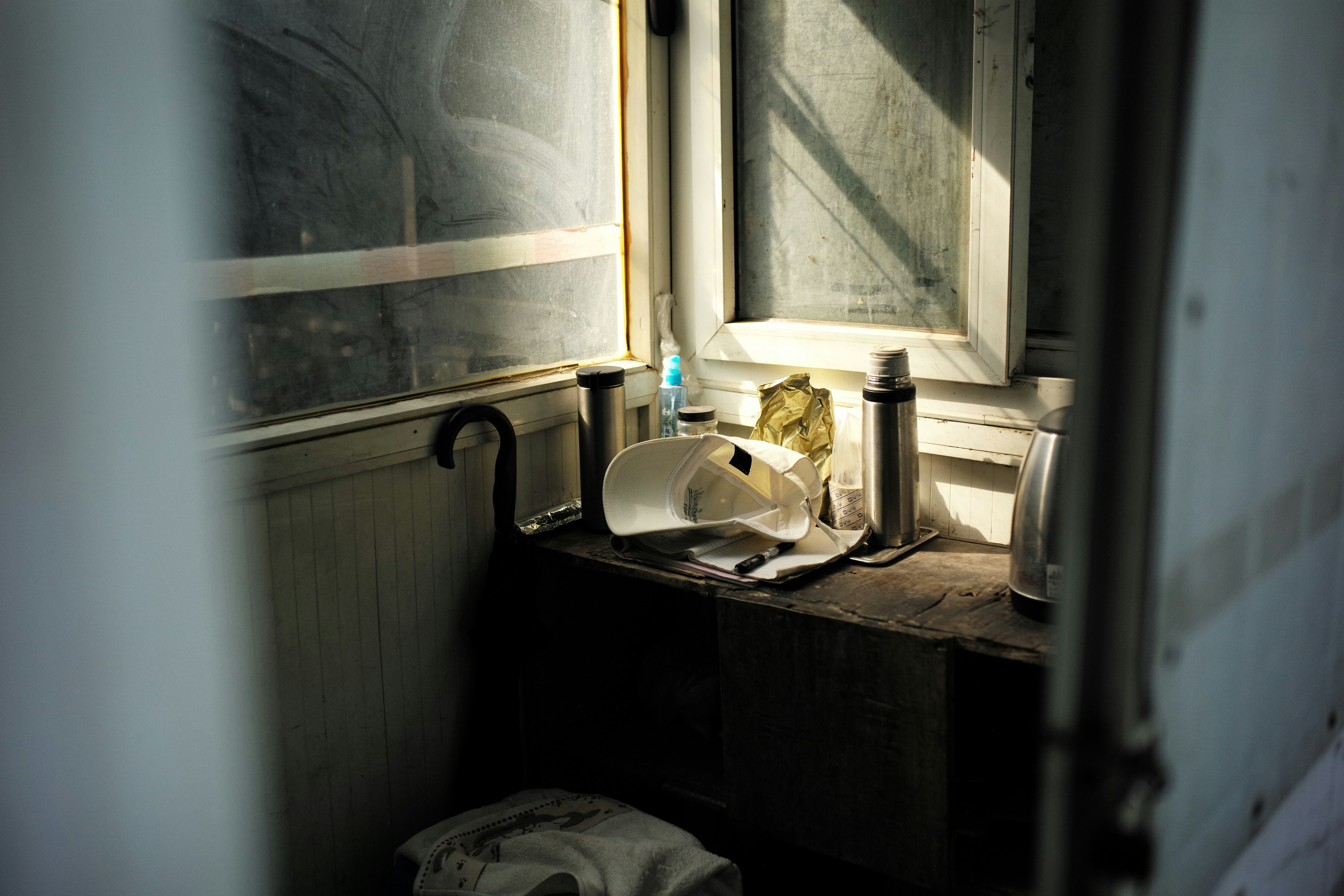 Dusty Windowsill Keepsake: A Quiet Moment in a Dim Kitchen