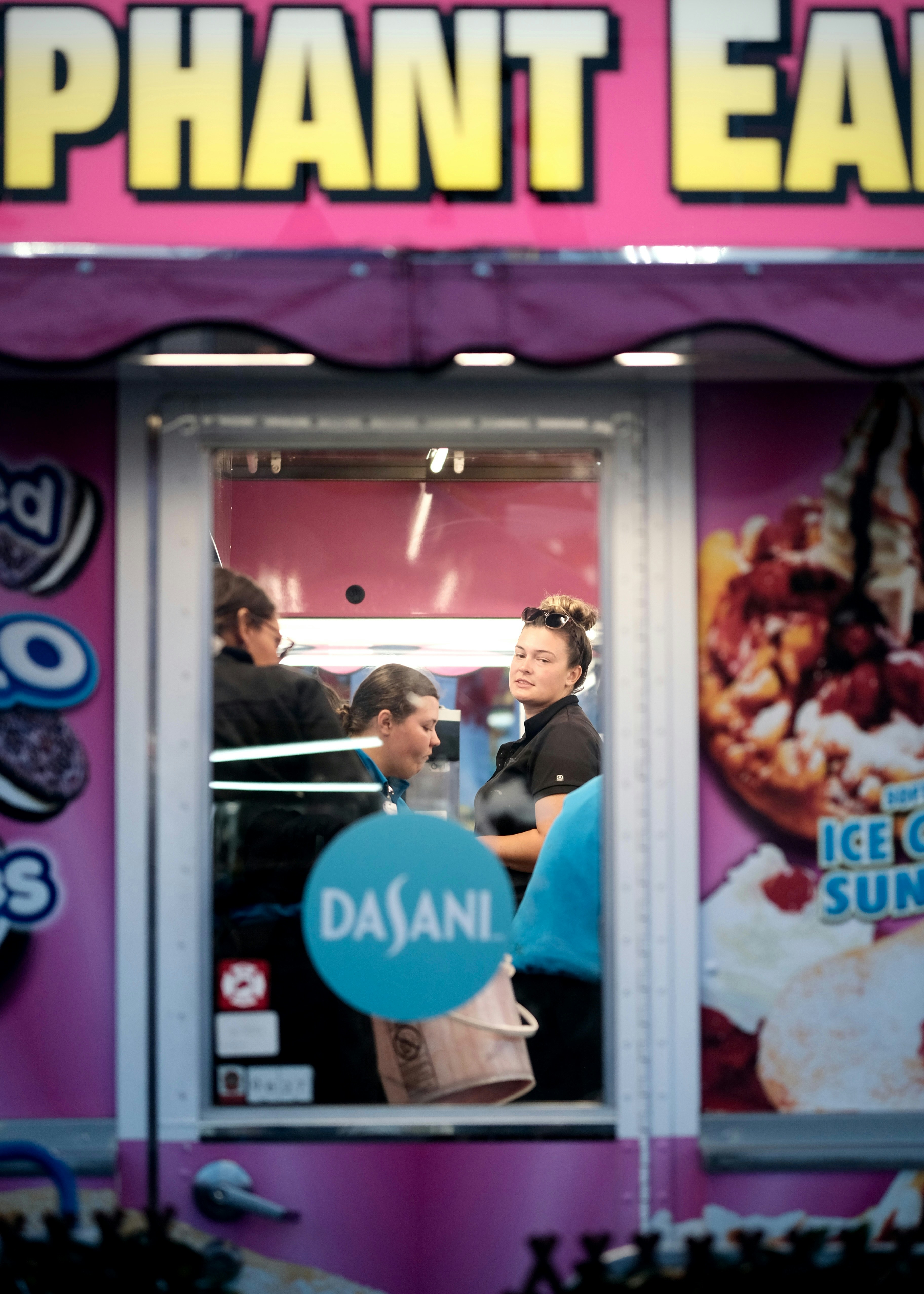 Inside the Ice Cream Window: Faces and Focus Within a Colorful Stand
