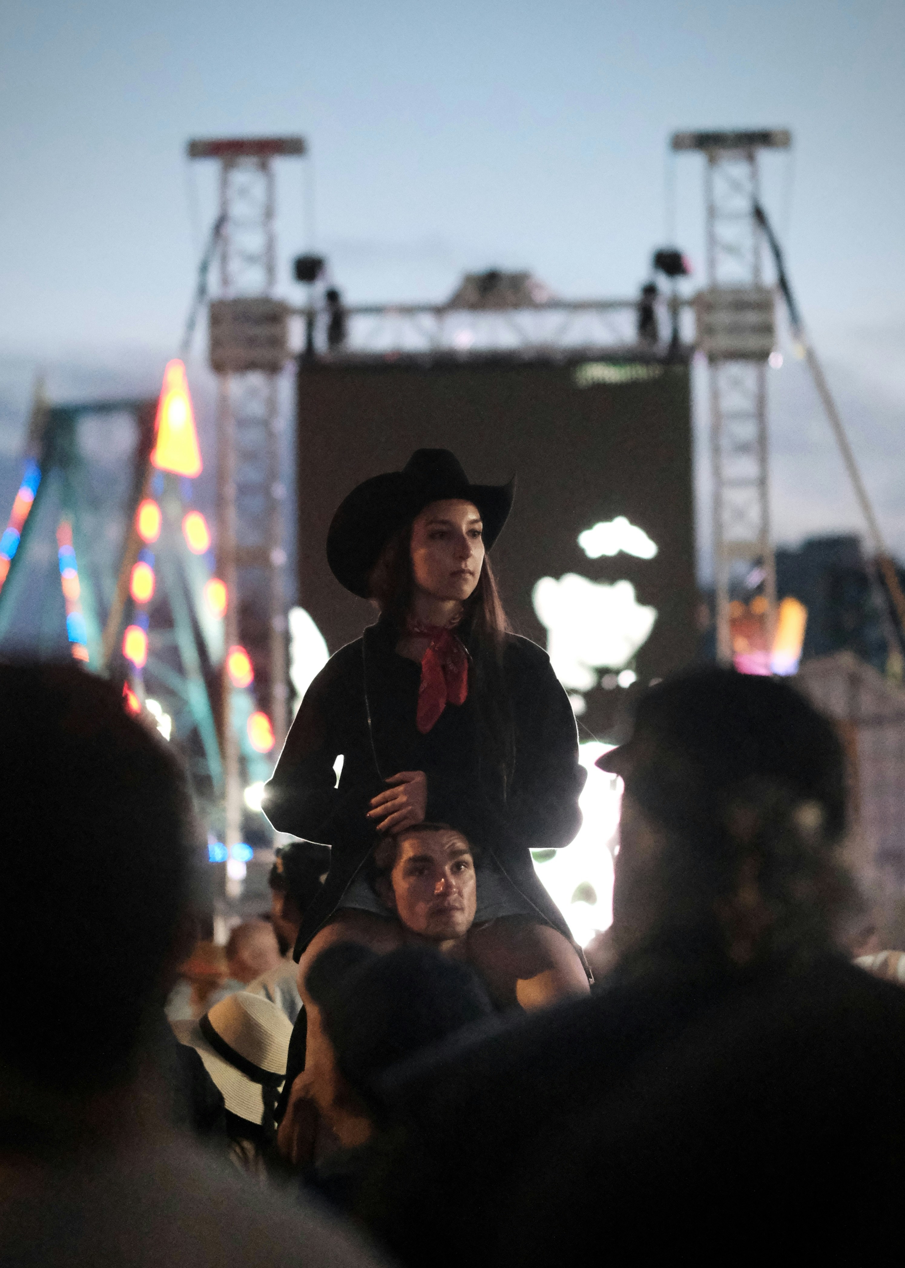 Lone Cowboy atop a Silhouetted Crowd at Twilight Stage