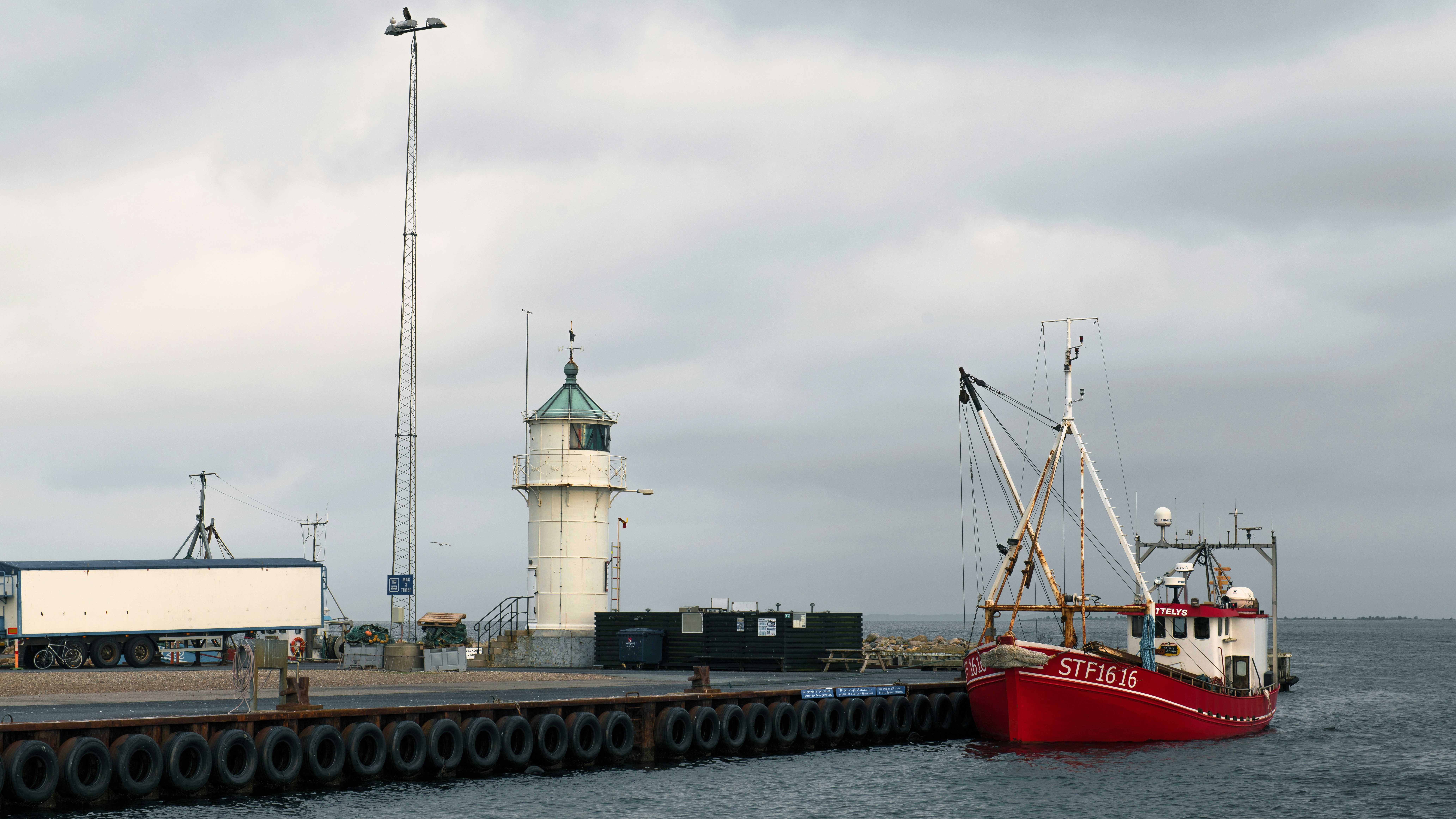 Red Tug at the Edge: A Quiet Harbor Scene