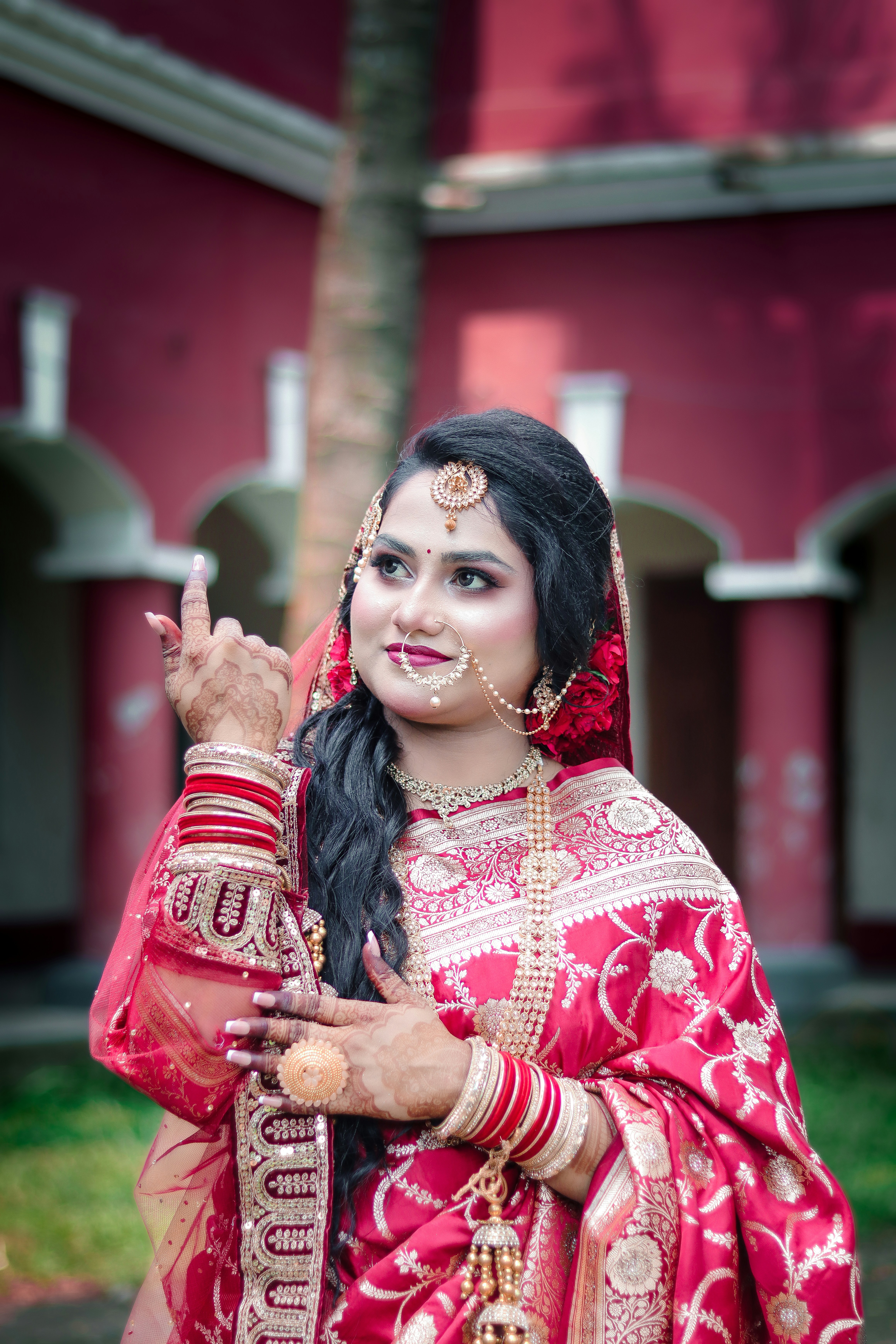 Red Silk Bride: Grace and Jewels Against a Rustic Courtyard