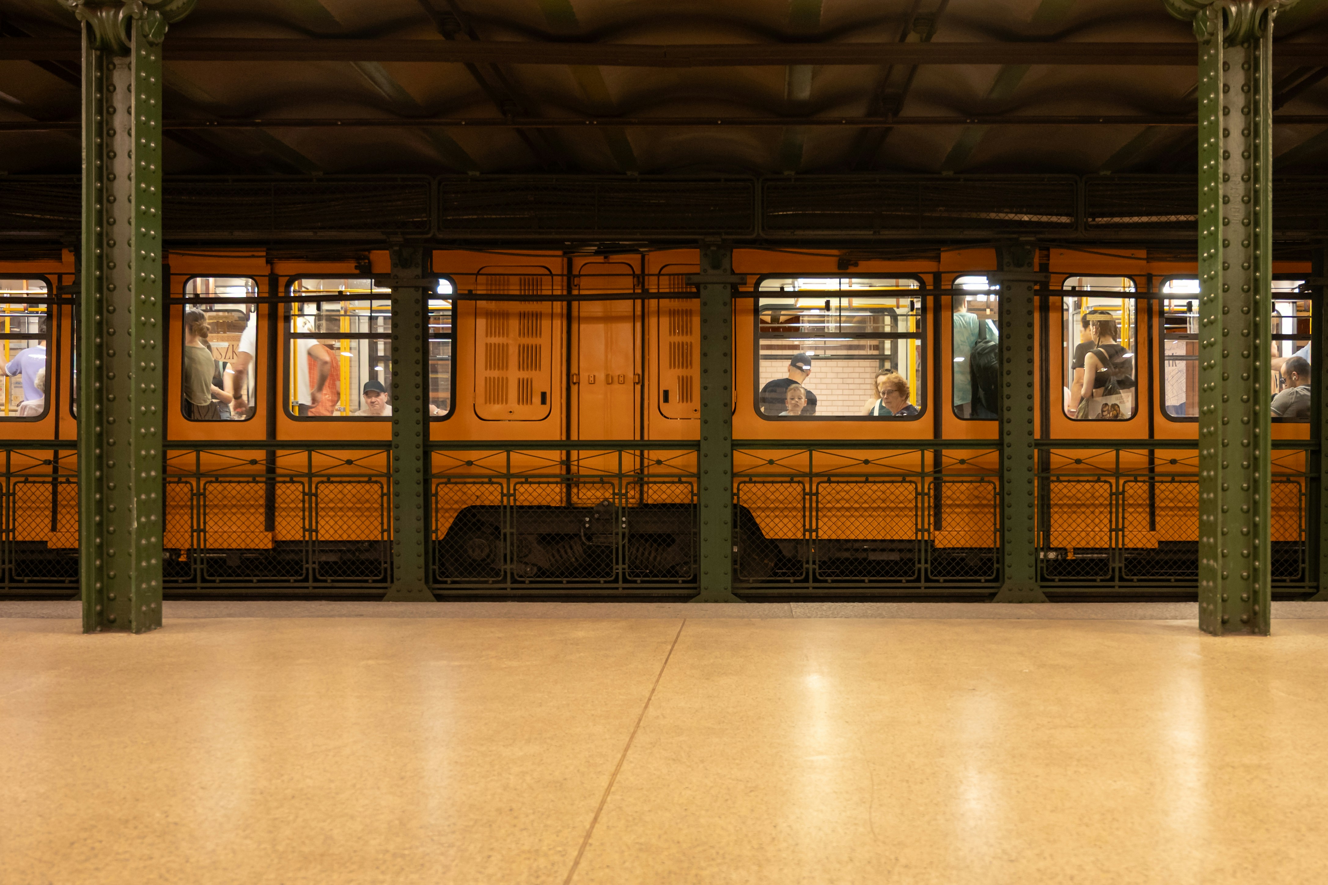 Orange Subwayscape: Passengers in a Quiet Awaiting Window