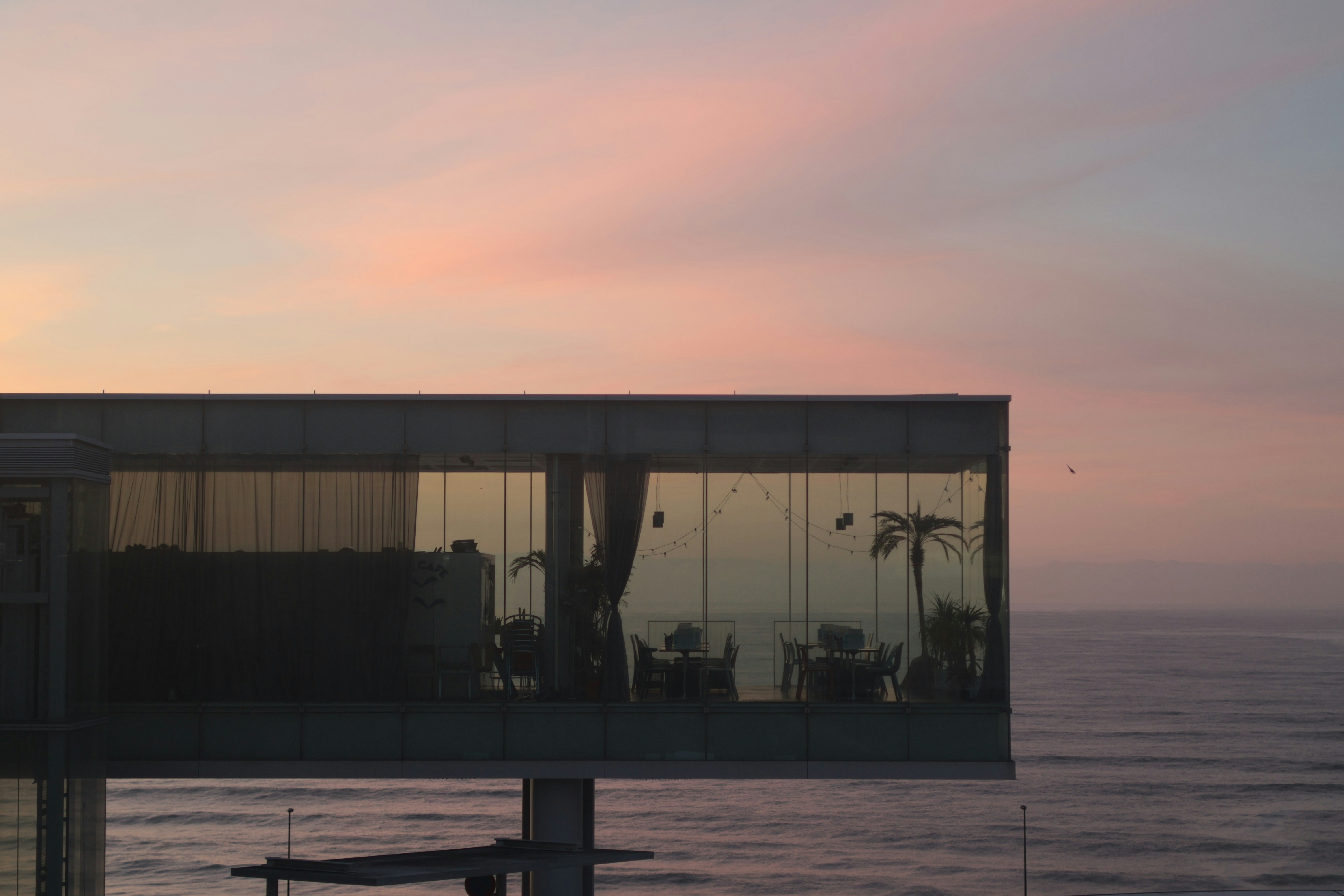 Glass-walled Terrace at Sunset Over Quiet Sea