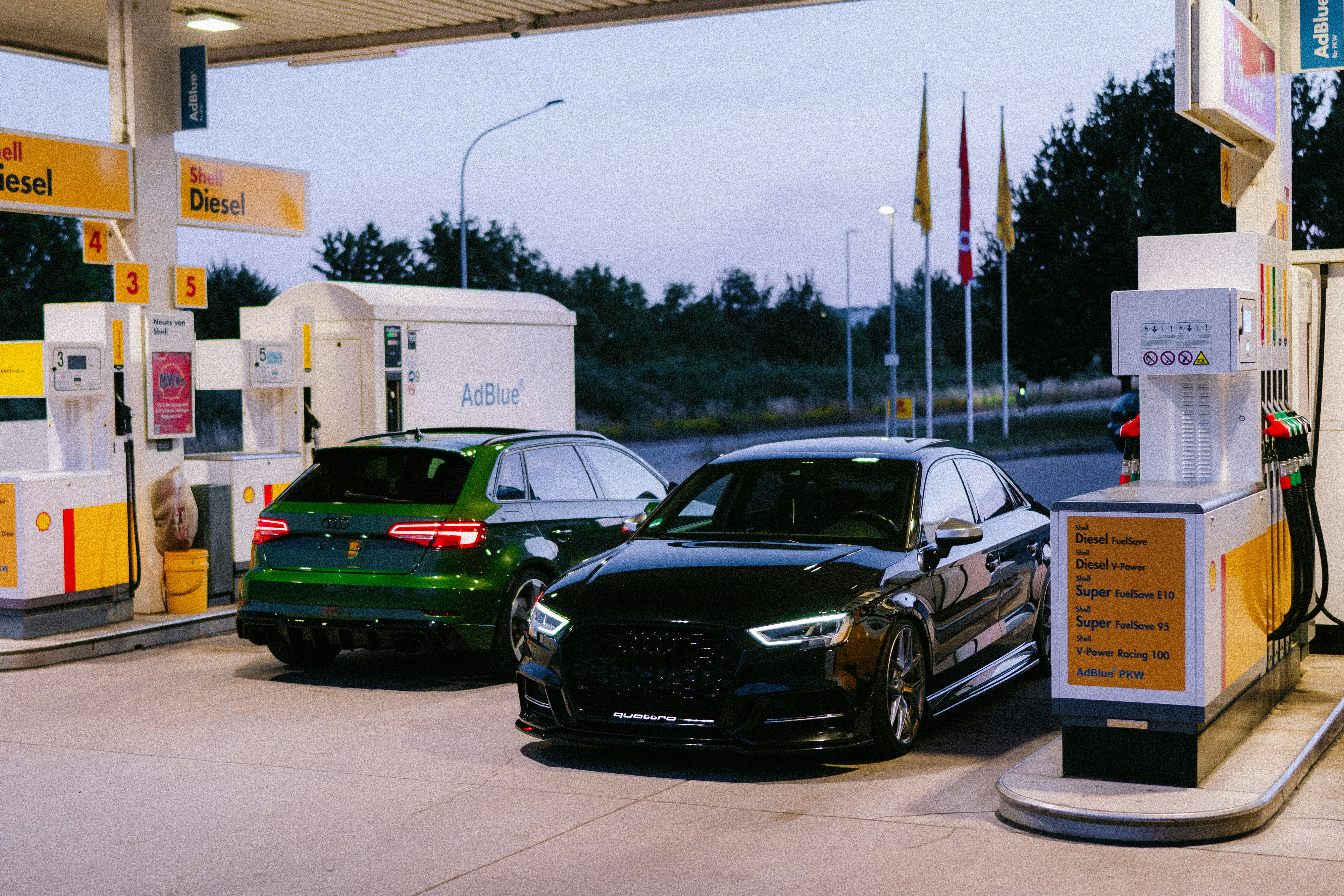 Black Sports Sedan at a Quiet Evening Gas Station