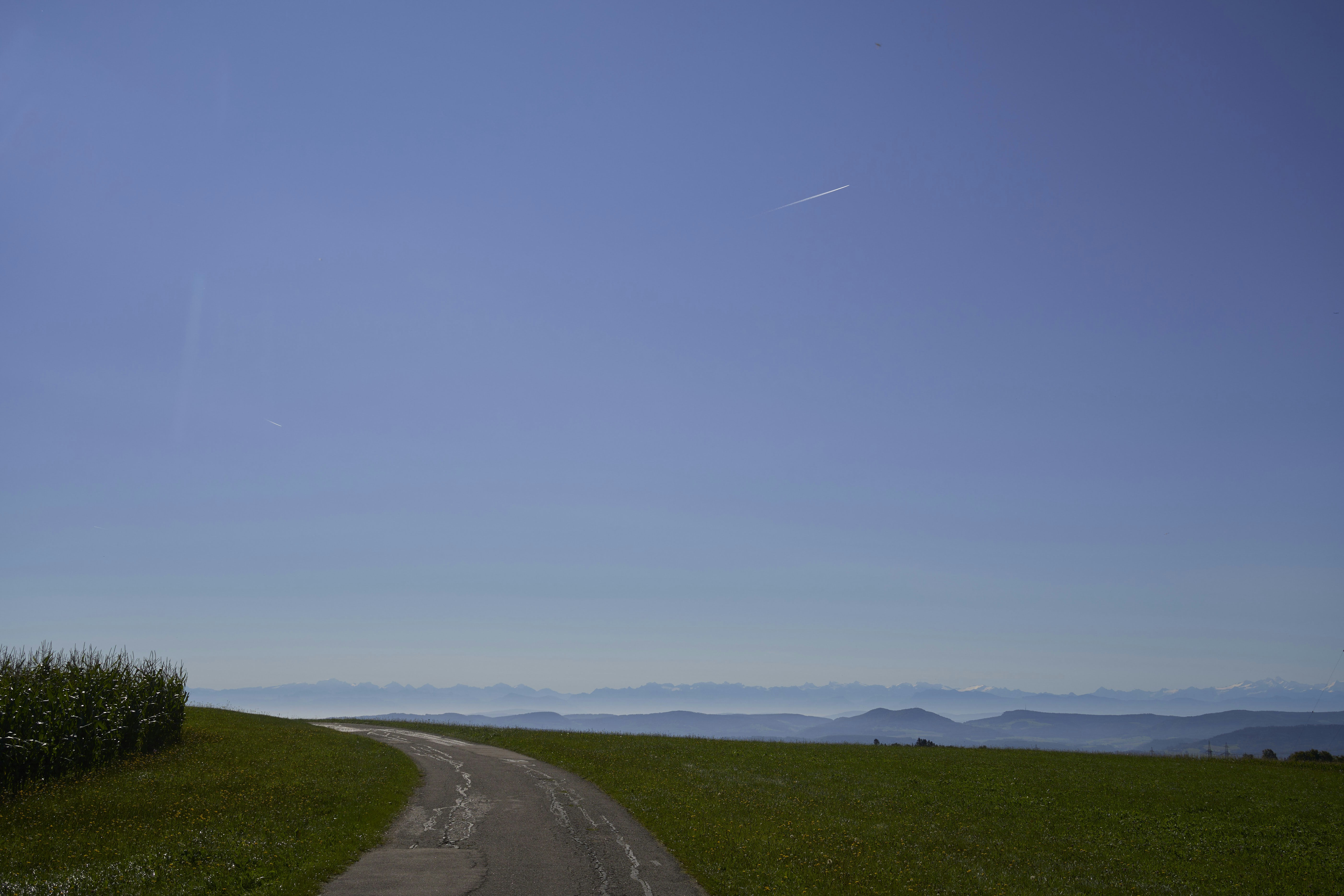 Path to the Far Ridge Under a Clear Blue Sky