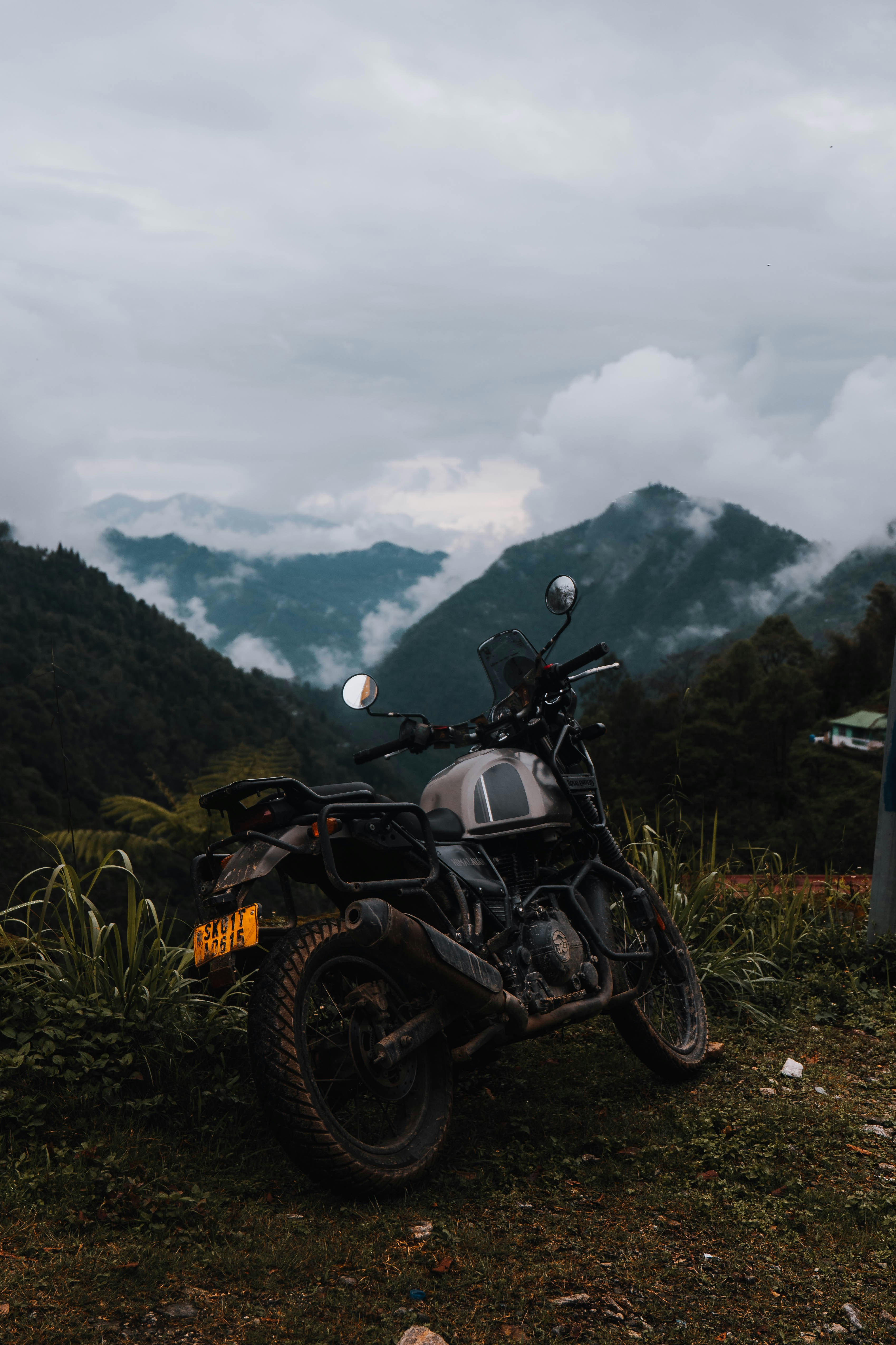 Rugged Motorcycle Overlook Beneath Misty Peaks
