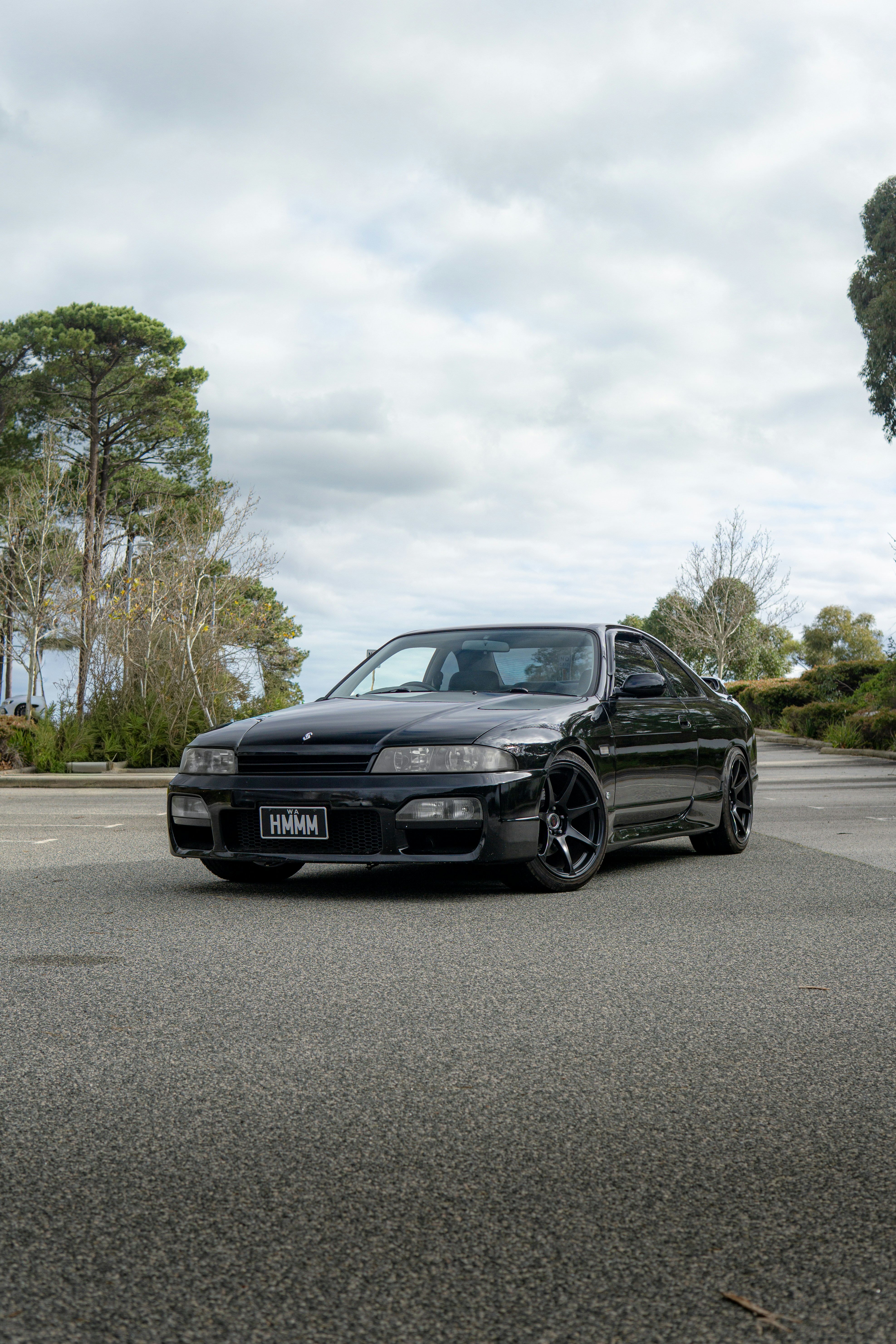 Black Nissan Skyline Wakes the Parking Lot at Dusk