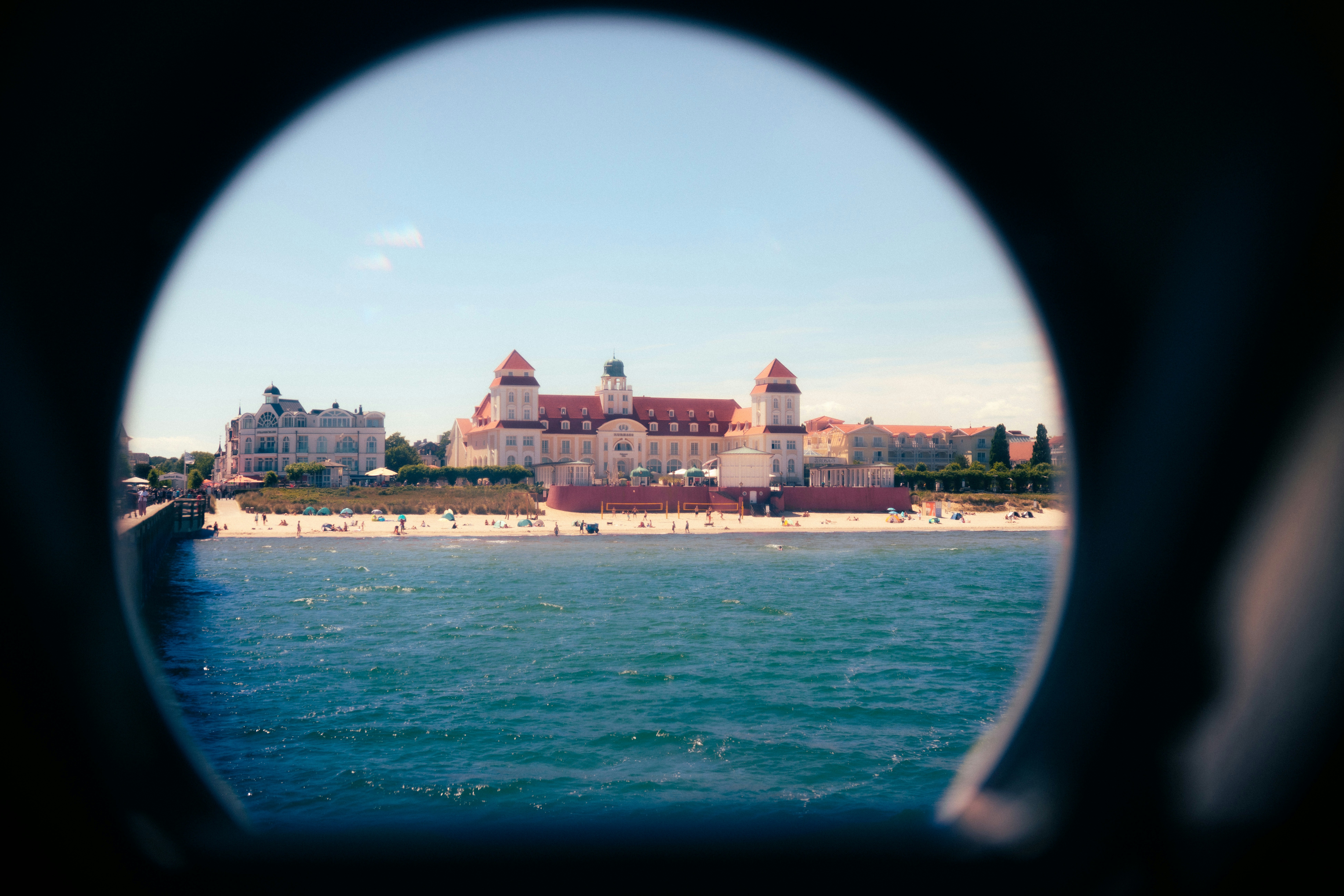 Castle at the Pedestal: A Seaside Vista Through a Circular Frame