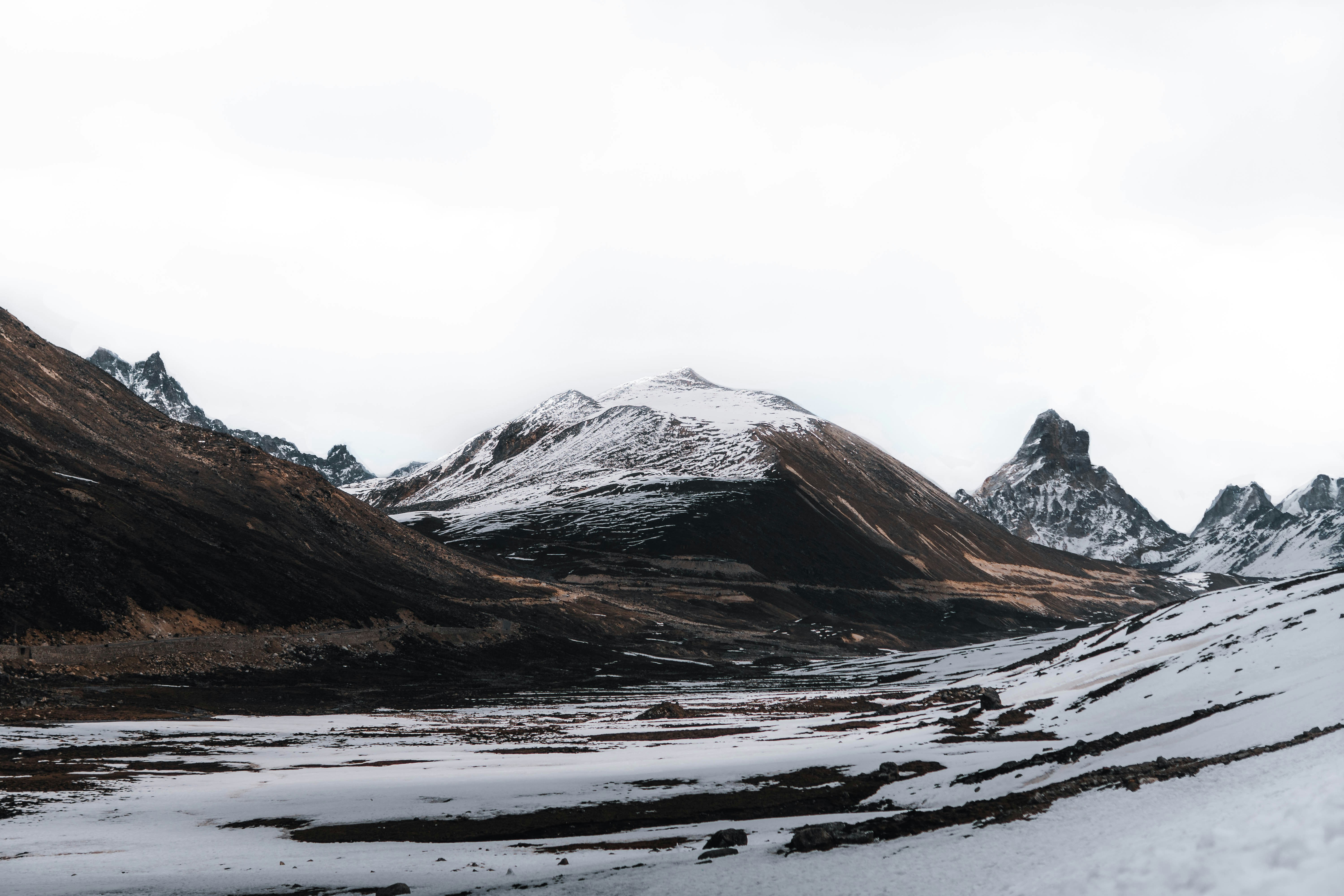 Snow-lit Valley Amid Rugged Peaks