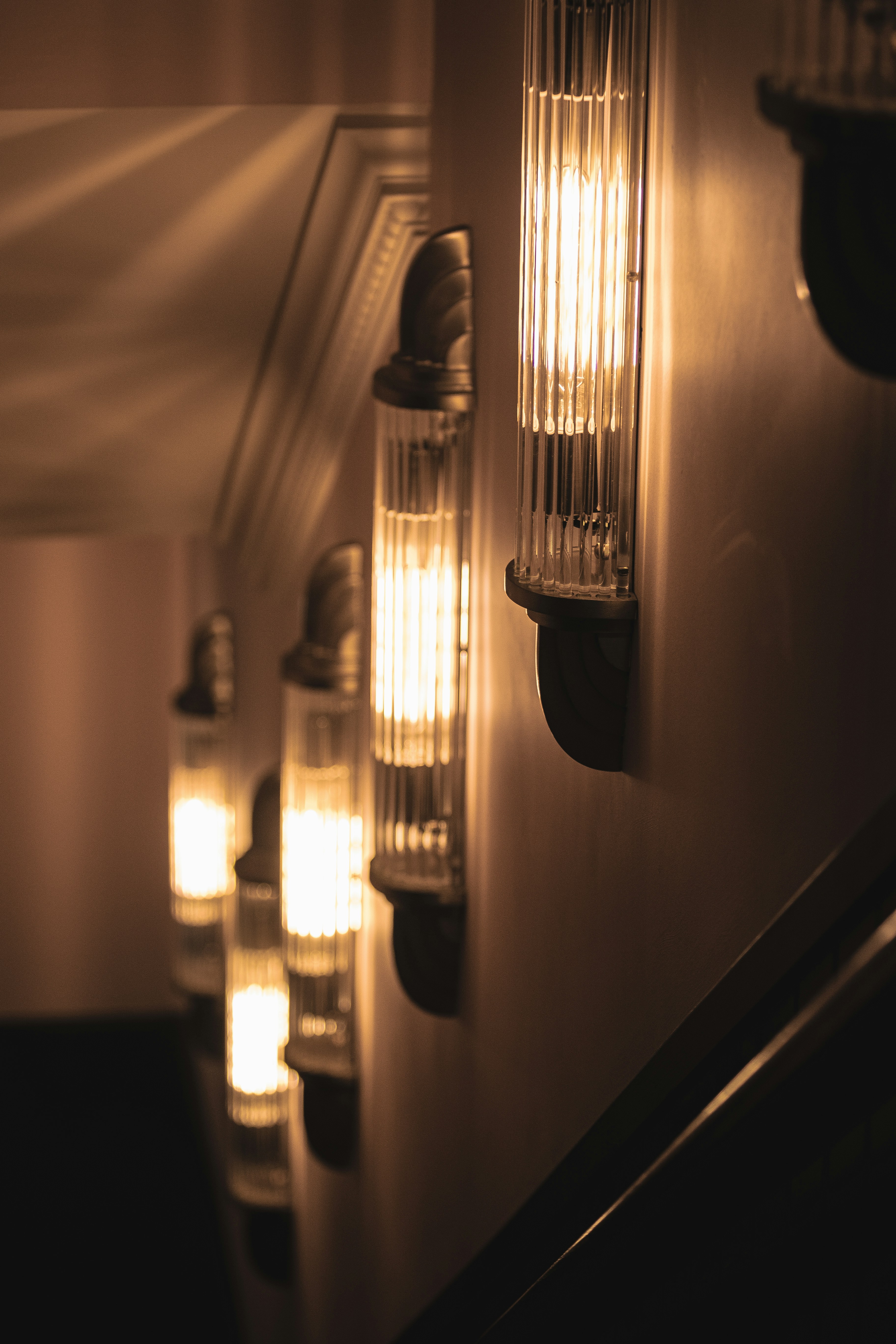 Warm industrial glow: a row of vintage wall lamps in a quiet corridor