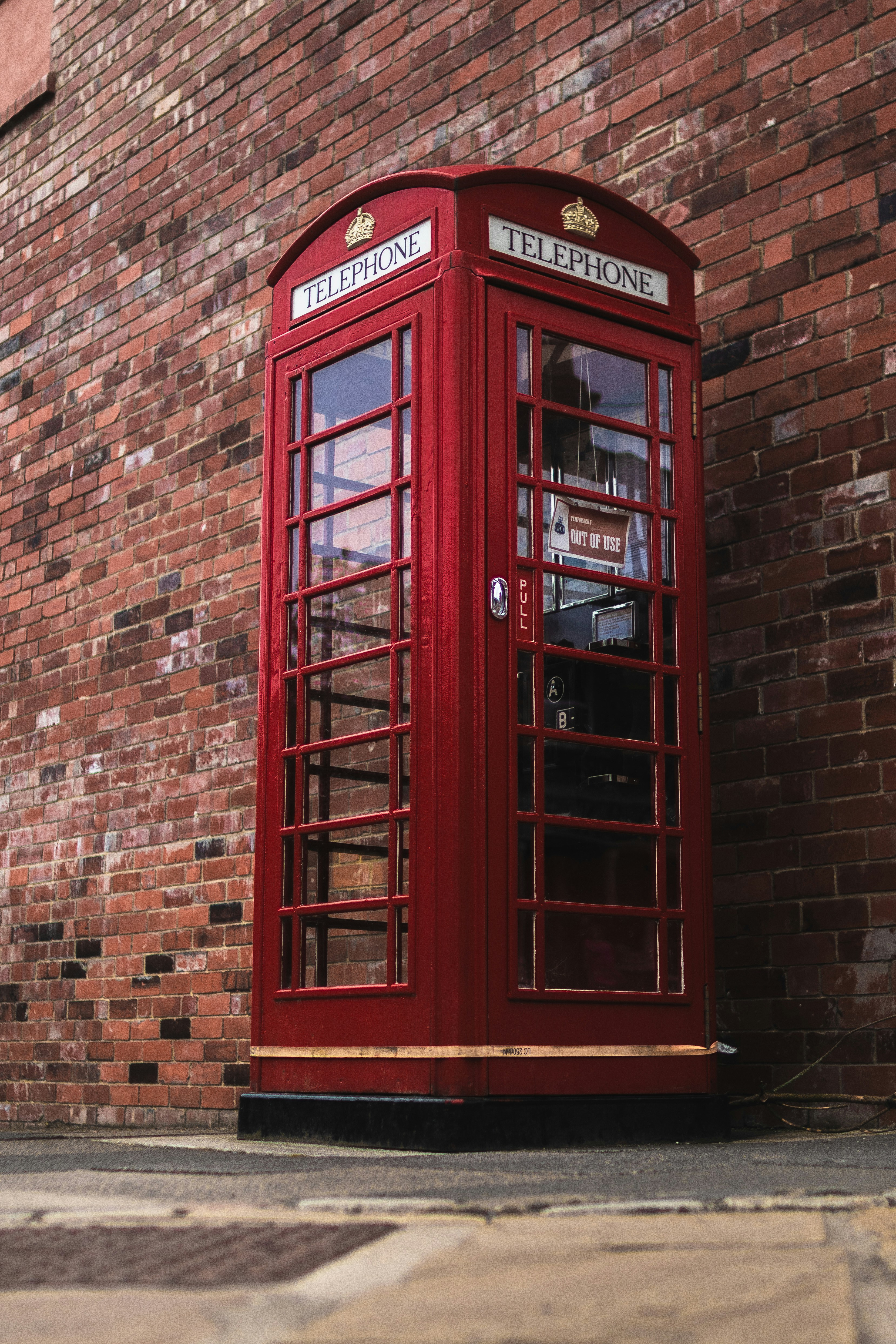 Red Telephone Box on Brick Corner
