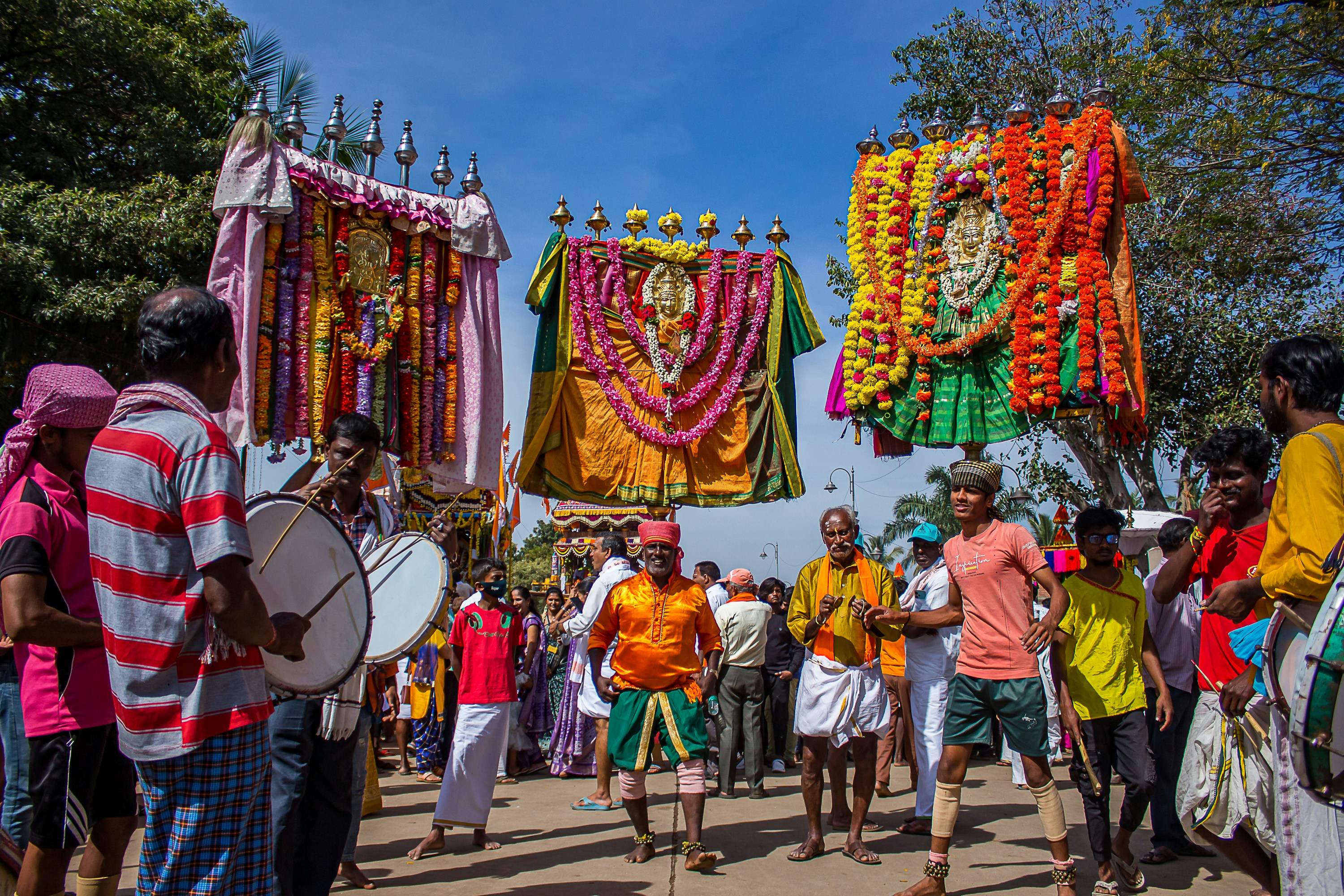 Colorful Festival Procession Under Floral Carvings