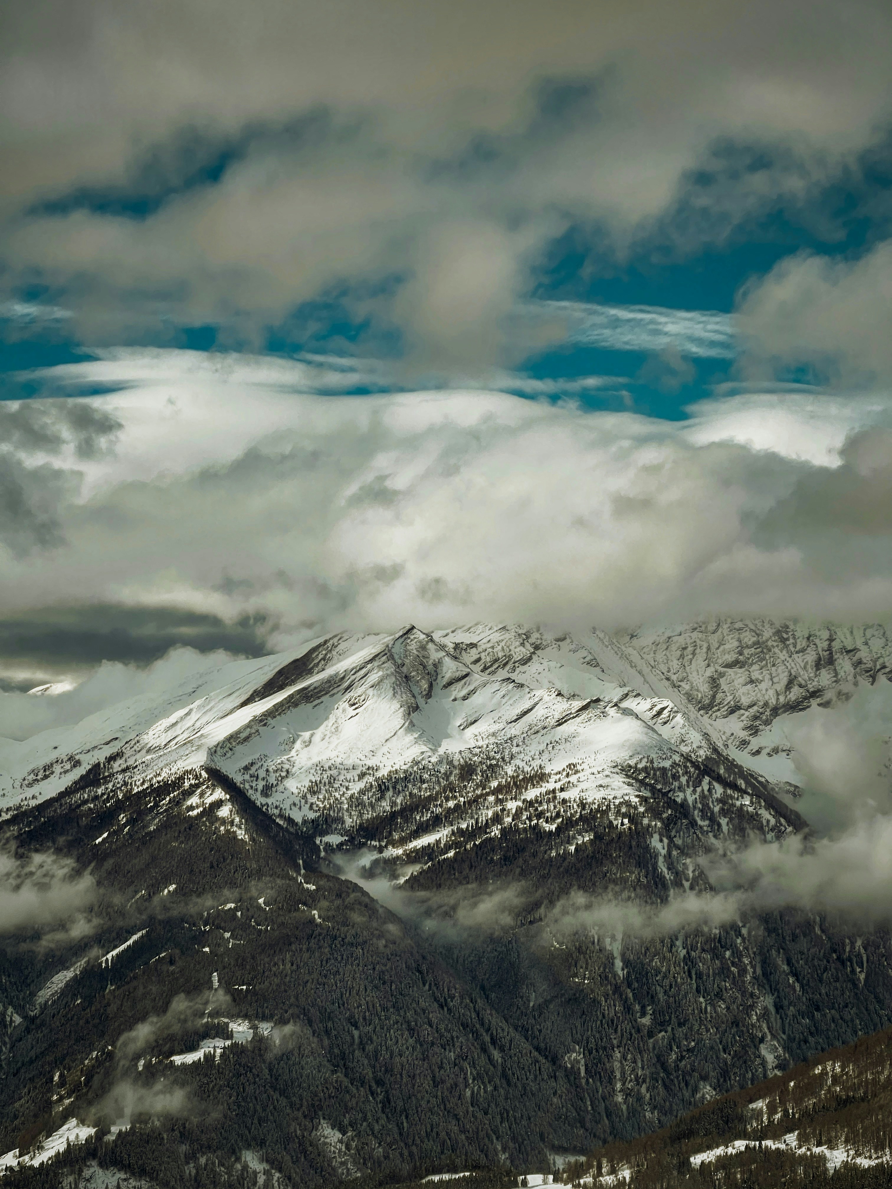 Snow-capped peaks breaking through cloud sea