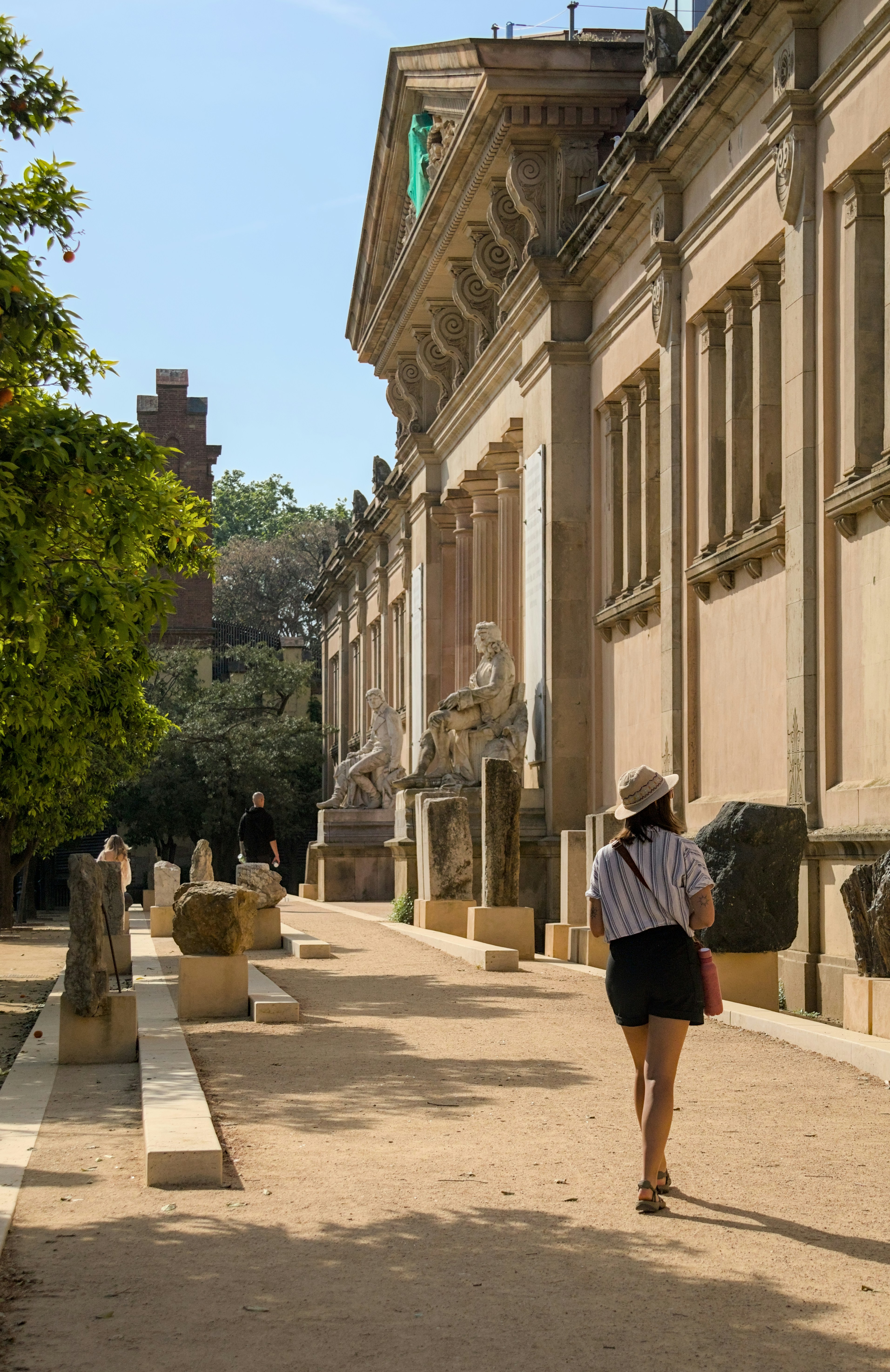 Footpath to History: A Visitor Walks Toward the Classical Facade