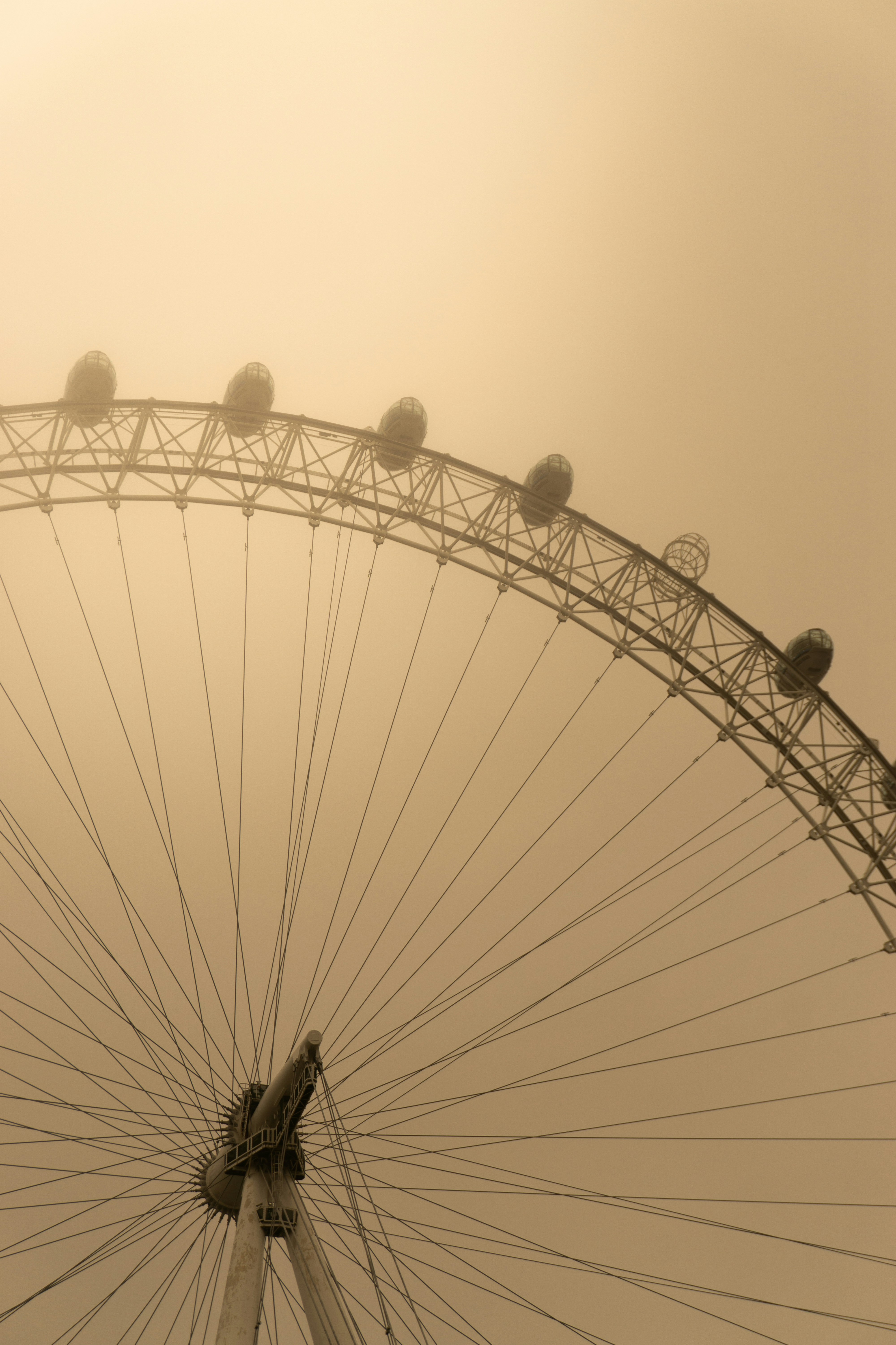 Silent Radius: The London Eye Reaches for Golden Mist