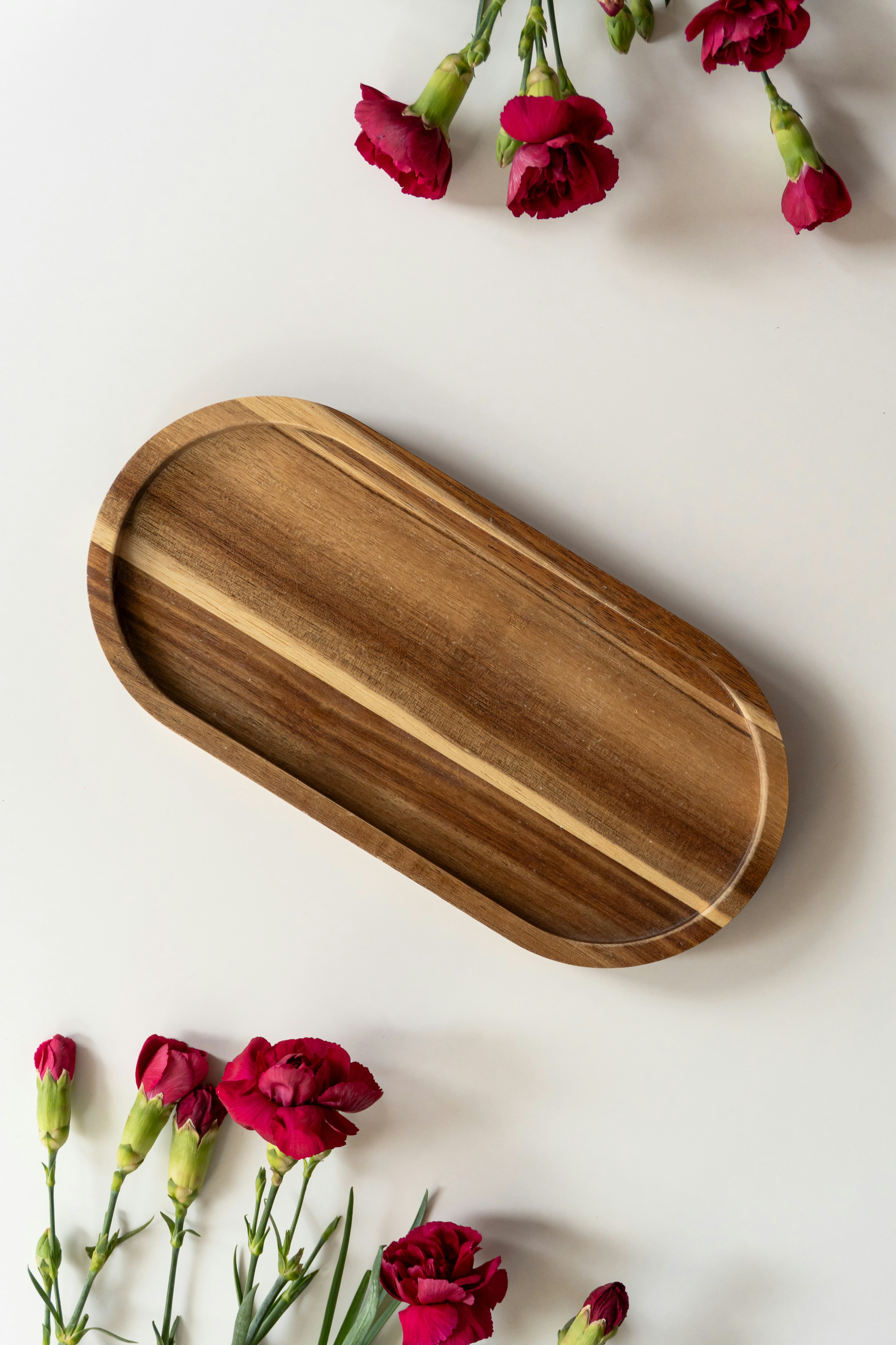 Mid-Century Wooden Tray Adrift Among Crimson Blooms