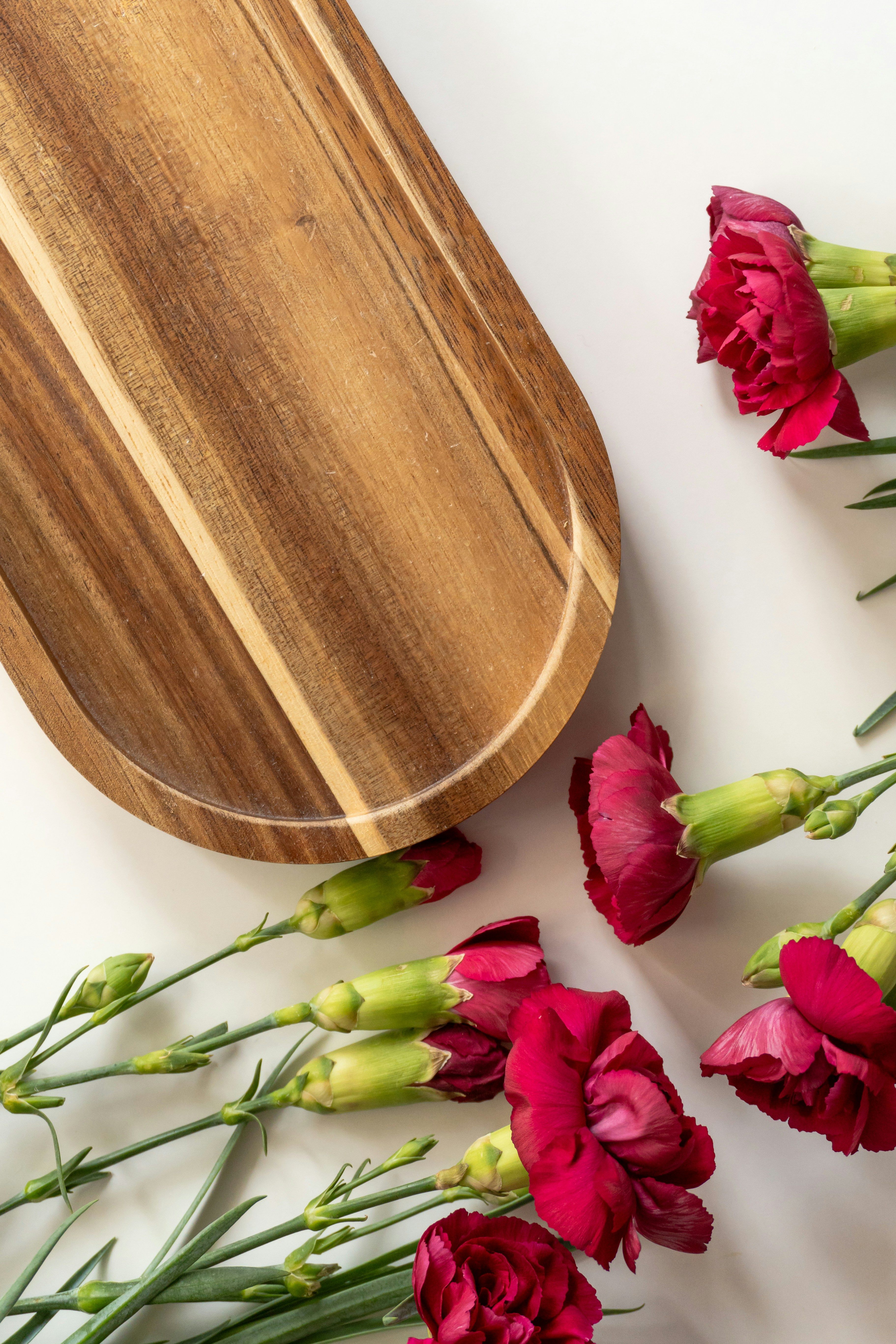 Wooden Paddle and Crimson Blooms: A Quiet Studio Still-life