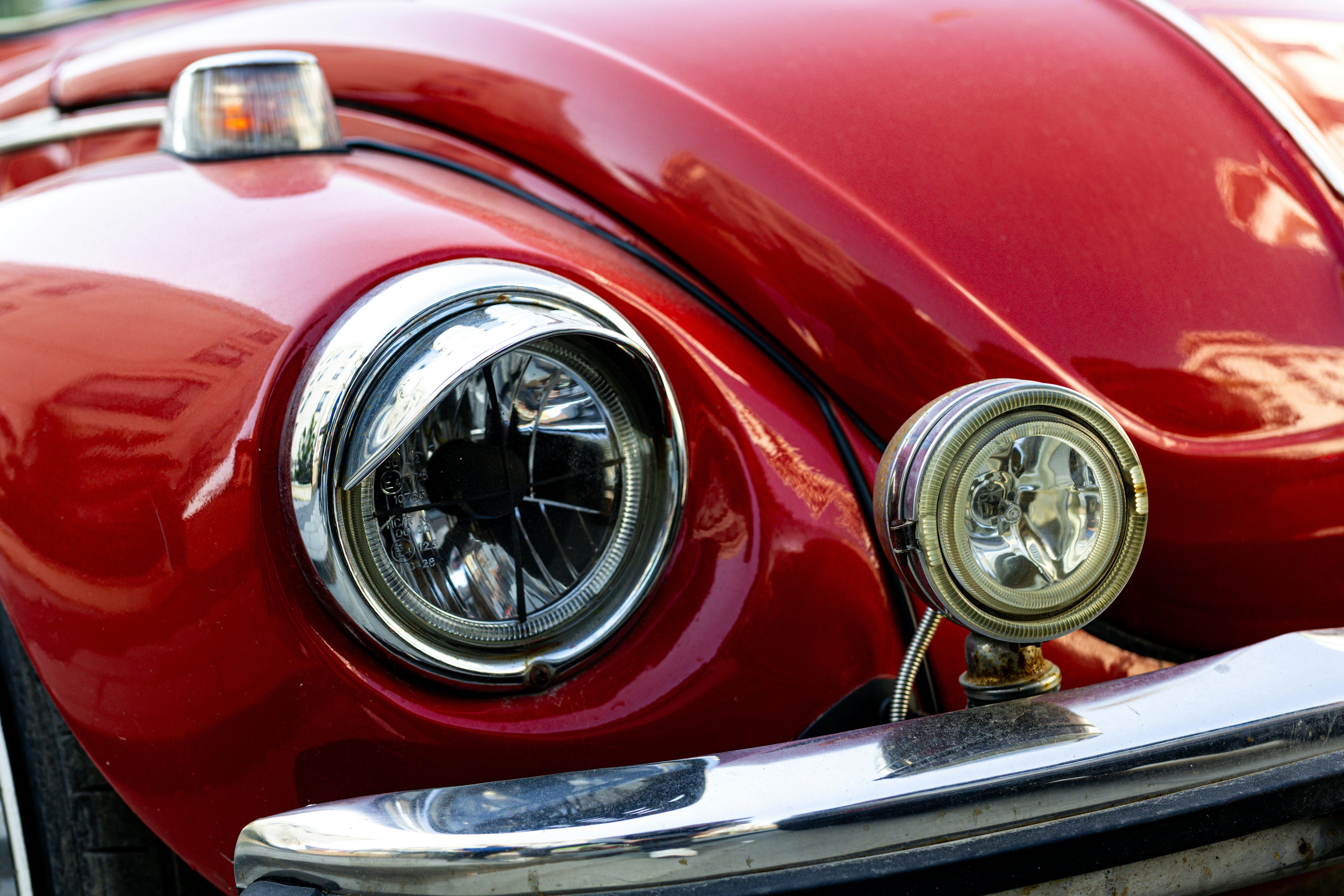 Ruby Chrome and Headlight Glint on a Classic Beetle Grille