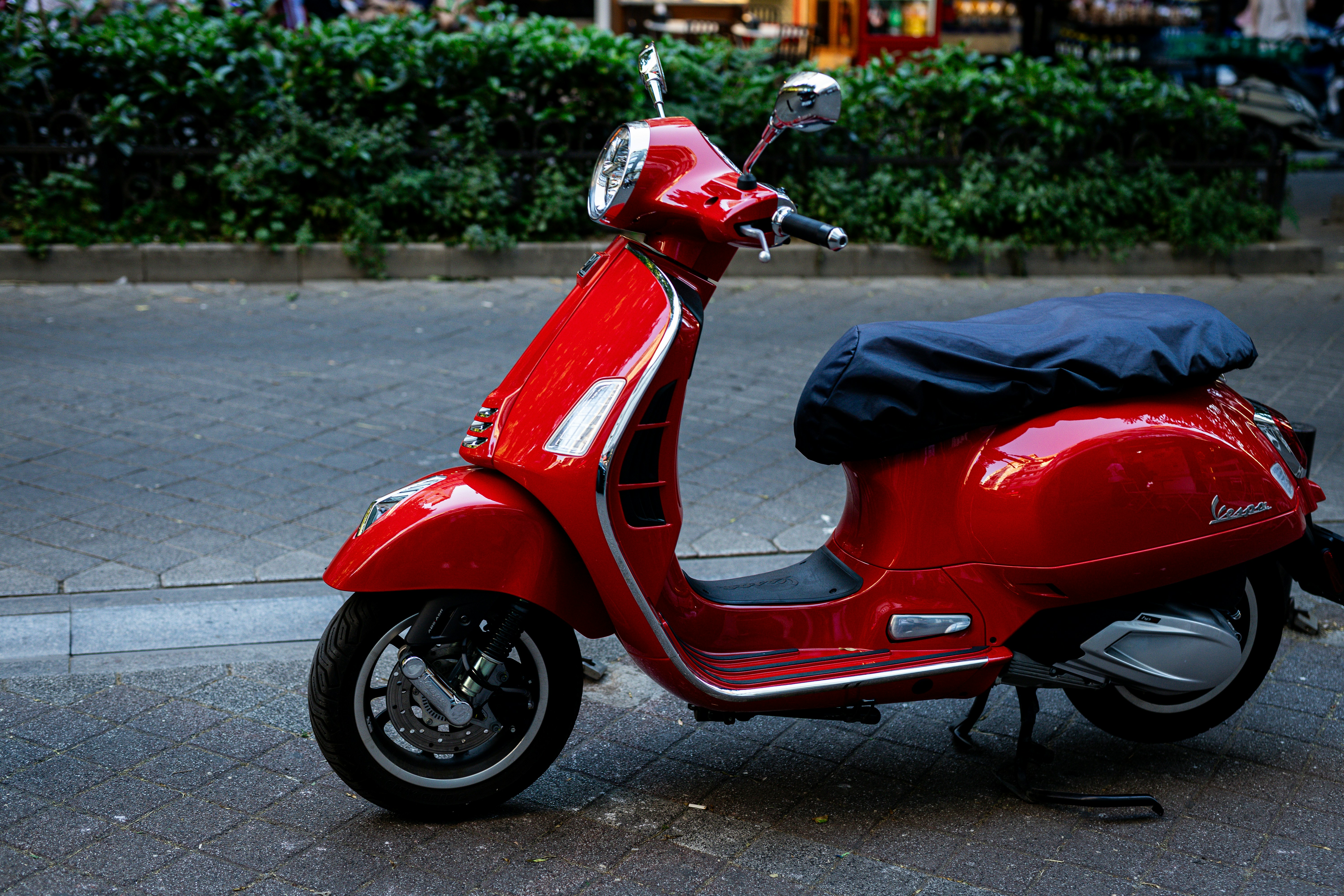 Crimson Comet: Classic Vespa Resting on a Quiet Street