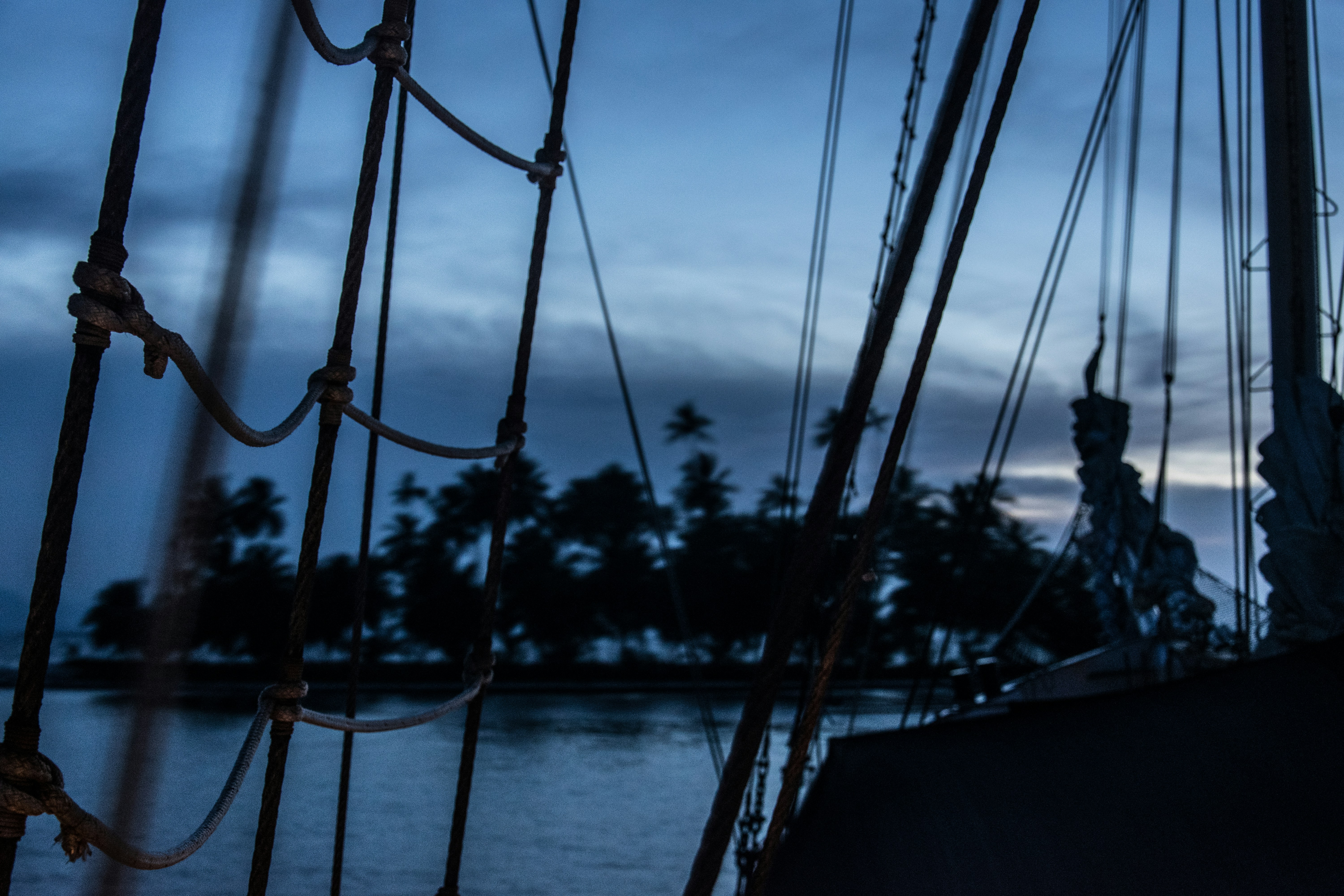 Rope and rigging against a dusky waterscape