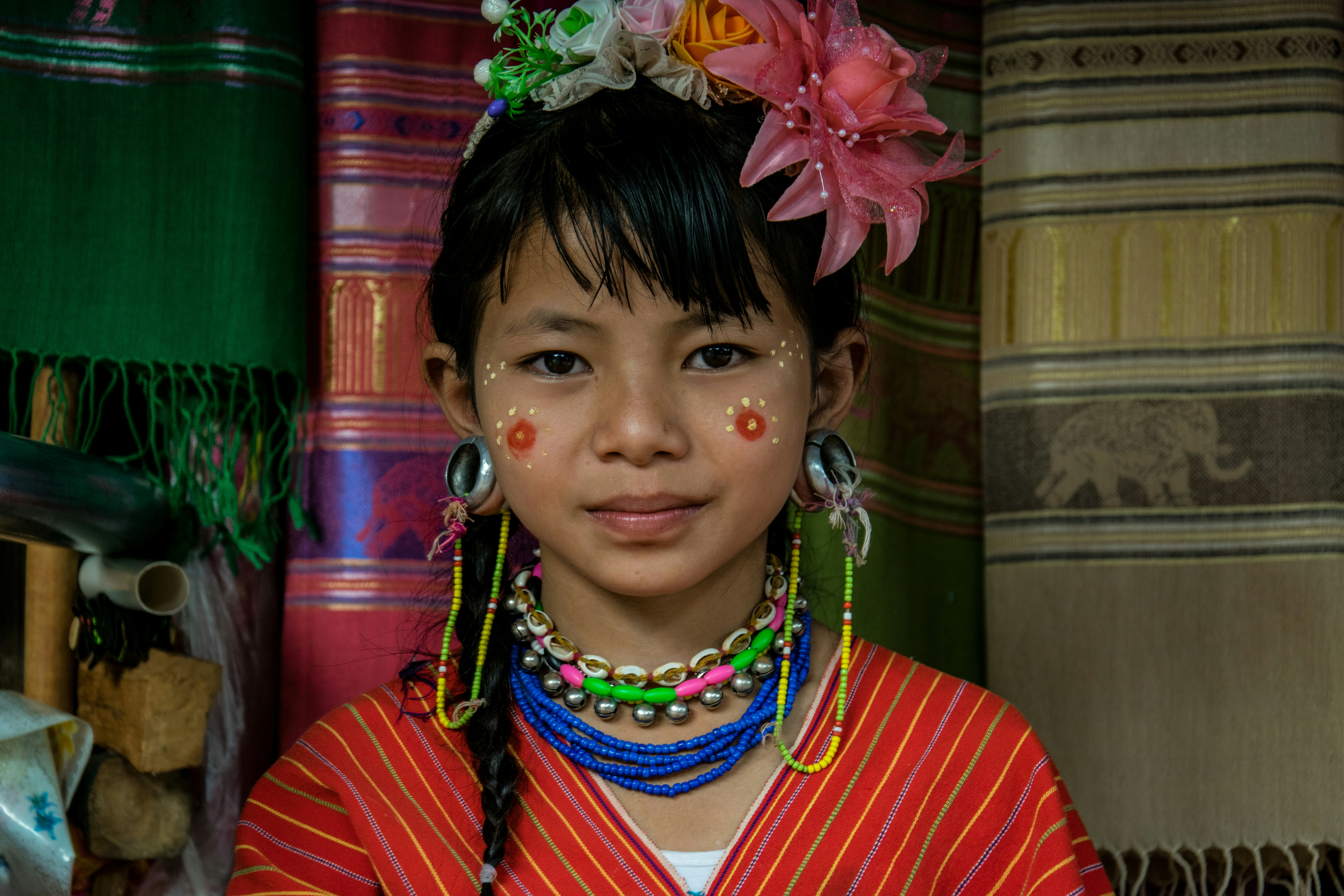 Colorful Adornments Frame a Child's Gentle Smile